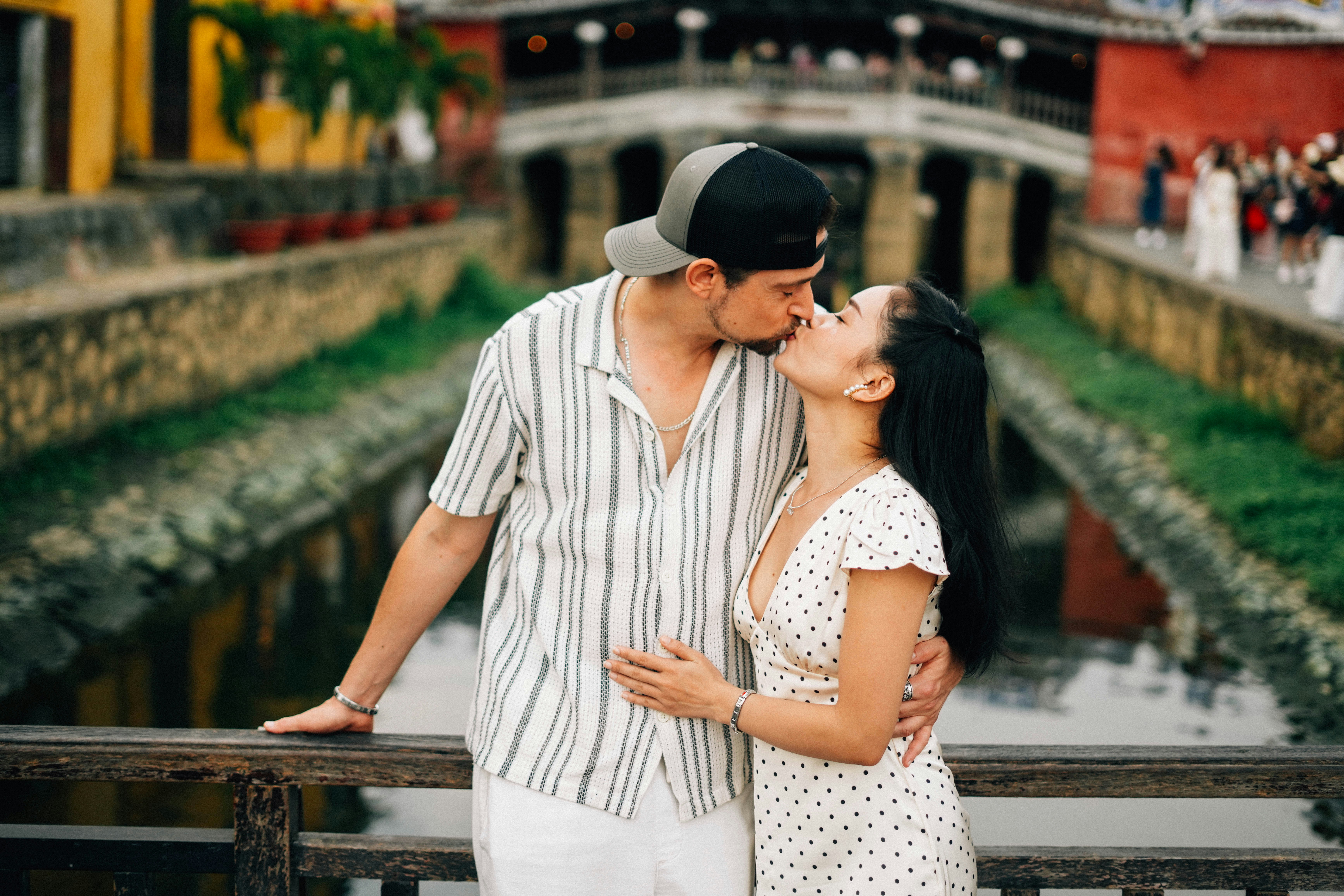 Kiss by the Canal: A Moment on the Bridge