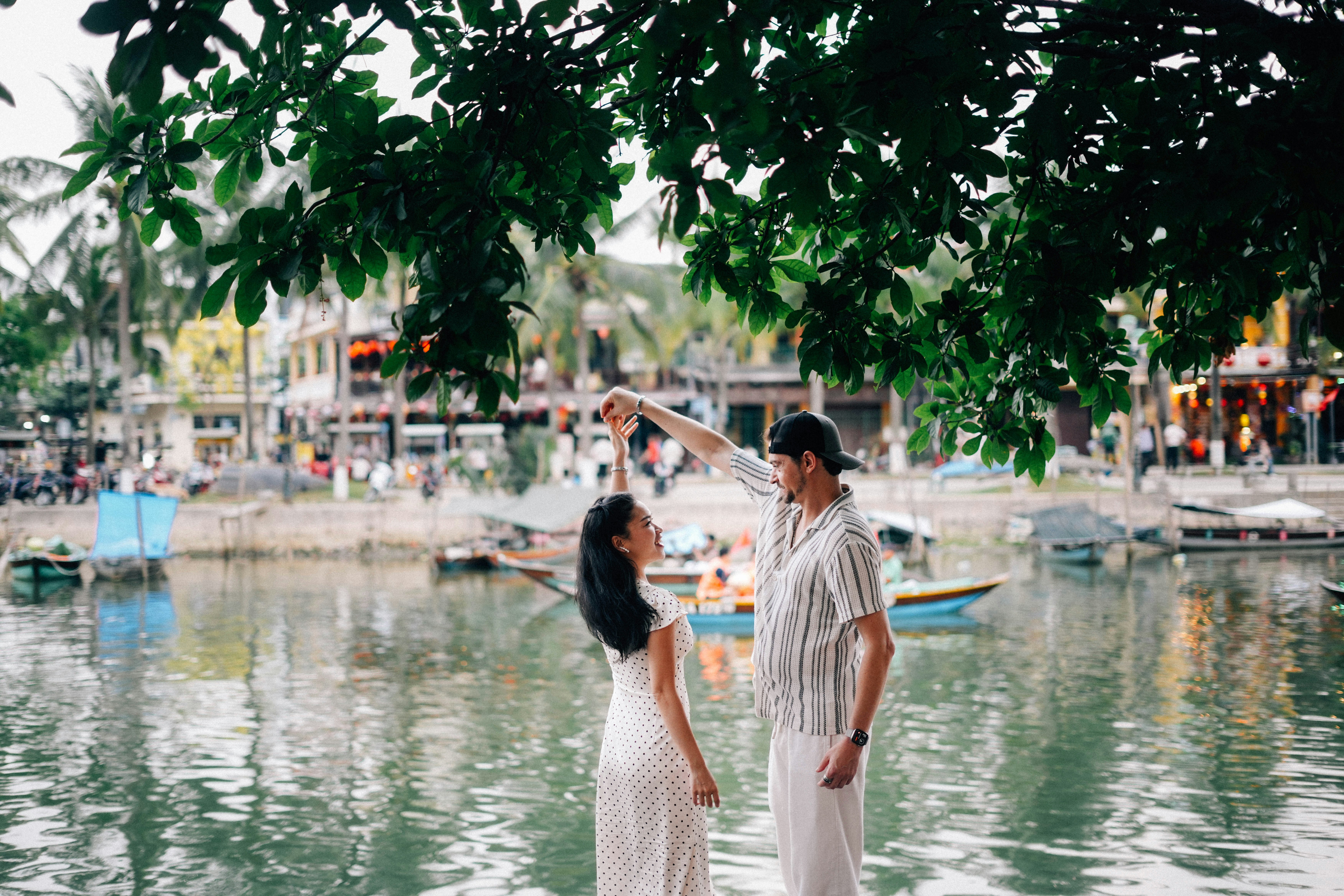 Dancing by the Quay: A Quiet Moment Under Green Canopy