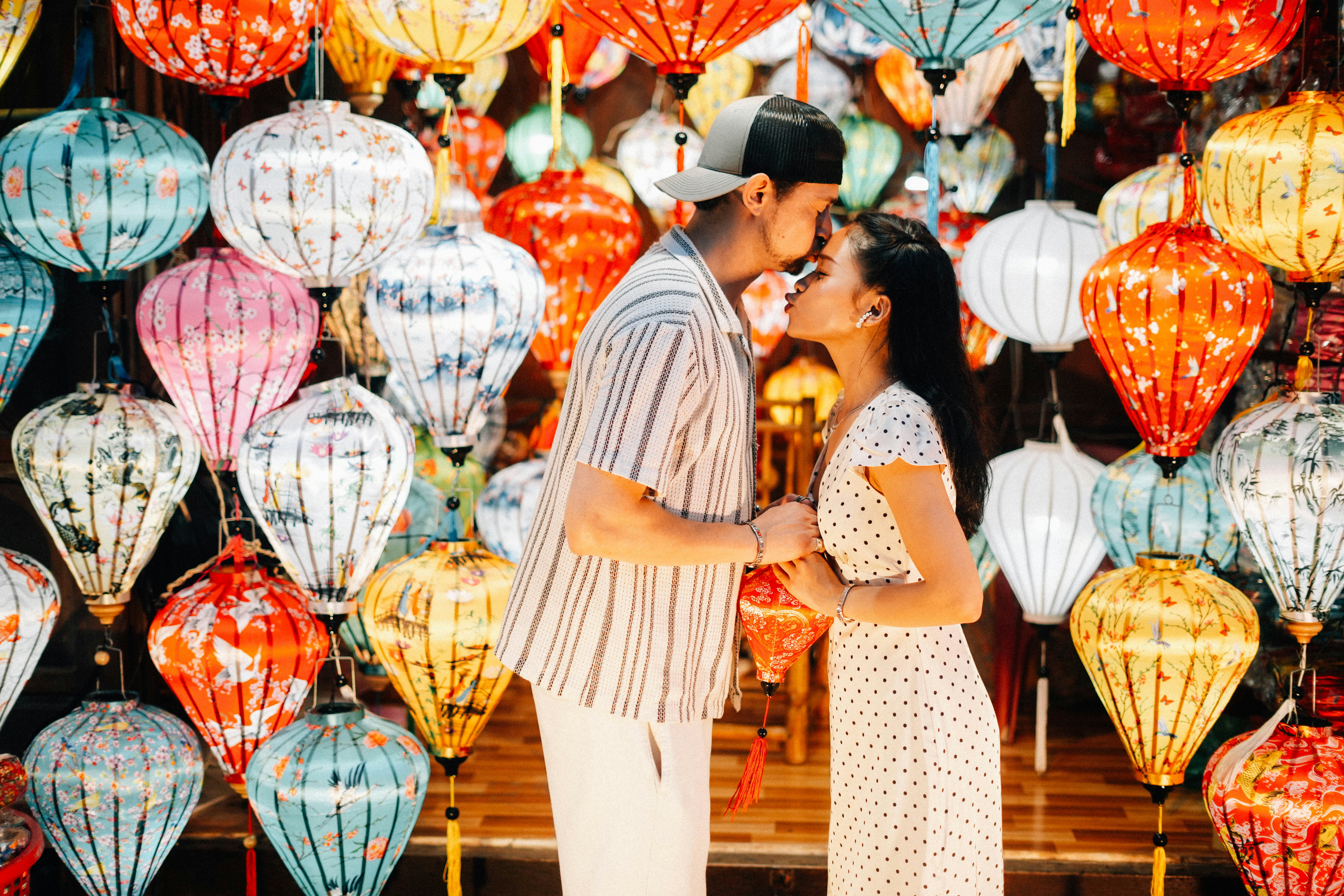 Kiss Amid Lanterns: A Moment of Quiet in a Burst of Color