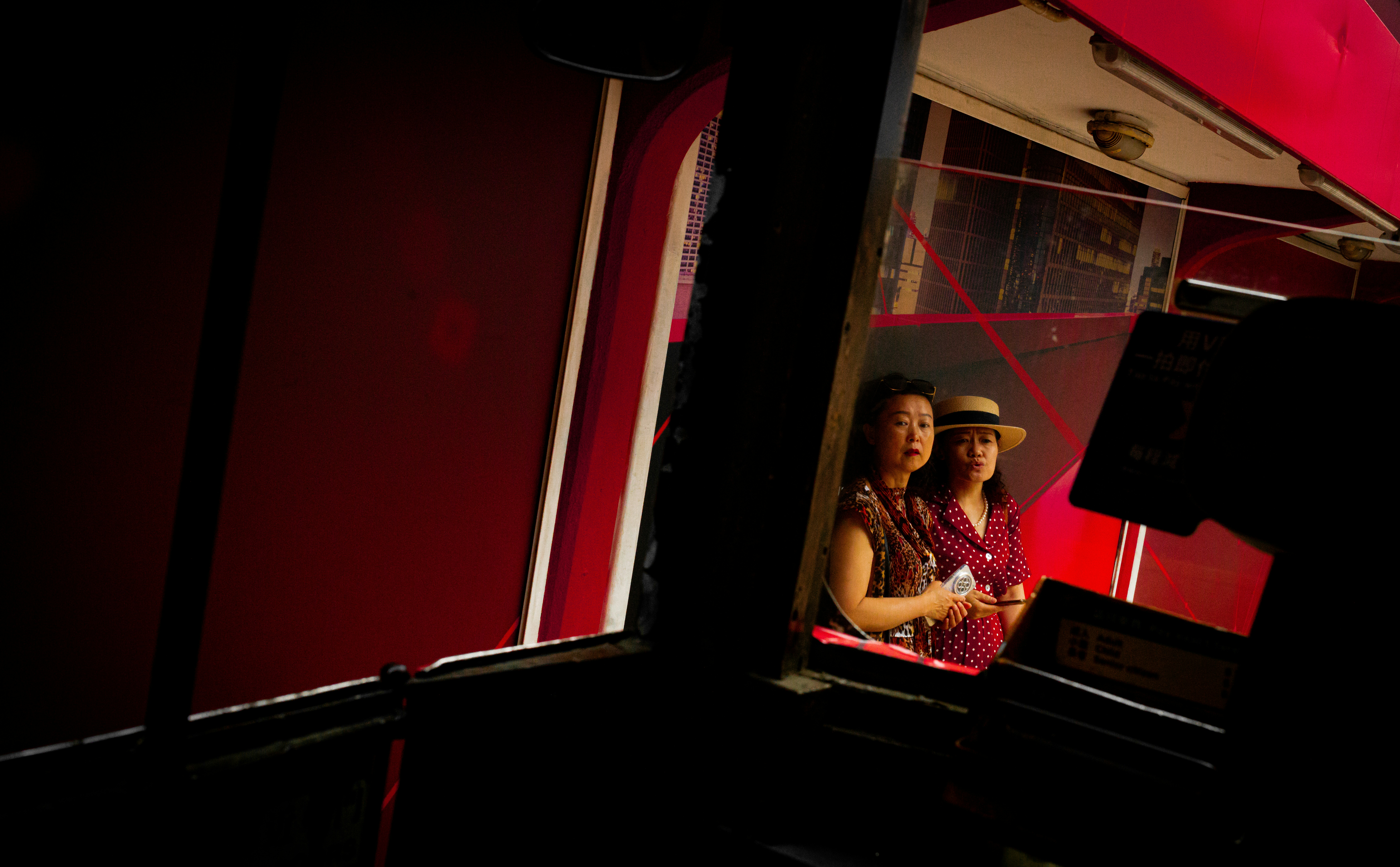 Two Women in Red: Quiet Conversation inside a Classic Red Setting