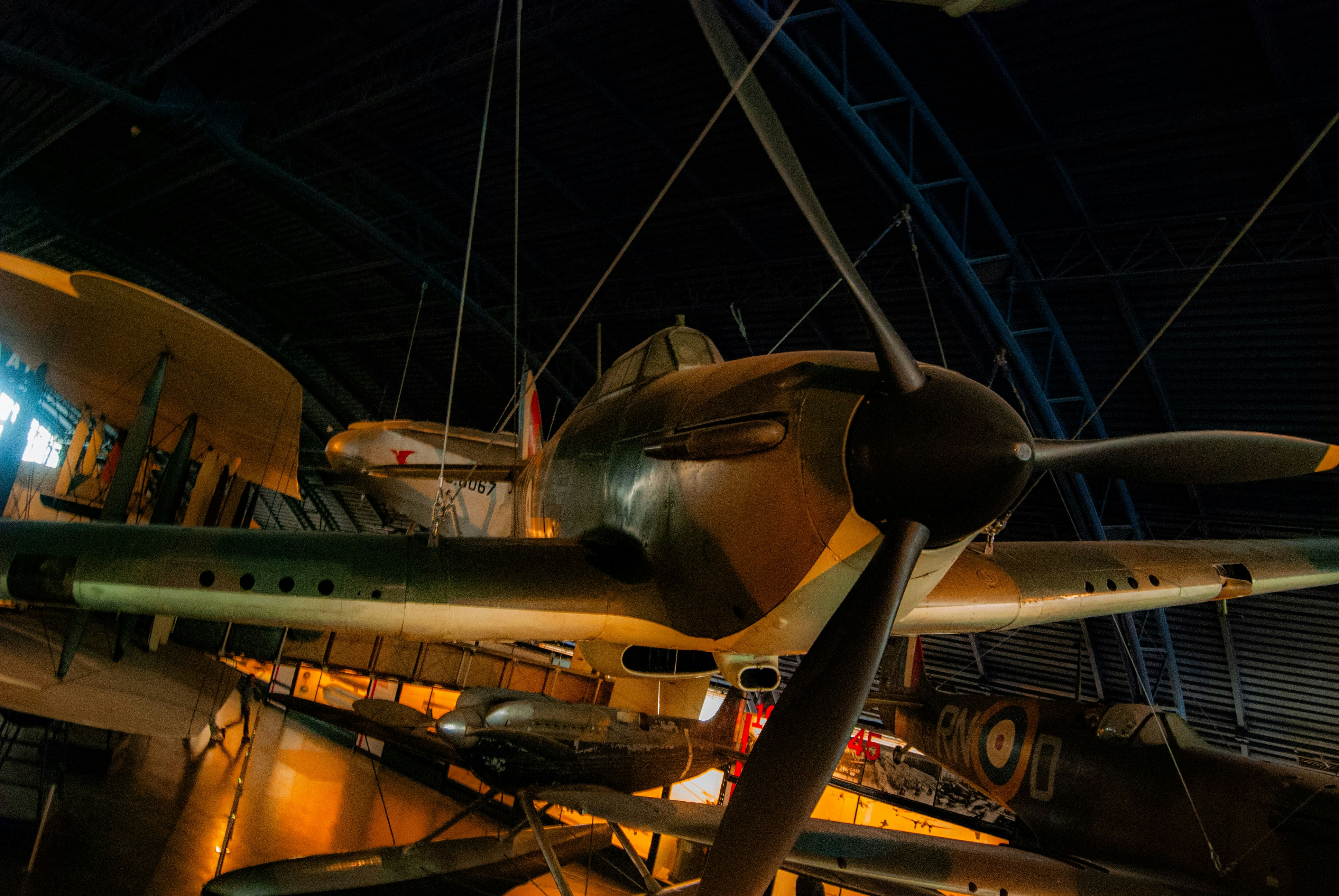 Propeller Spirit: A Vintage Aircraft Resting in Dim Hangar Light