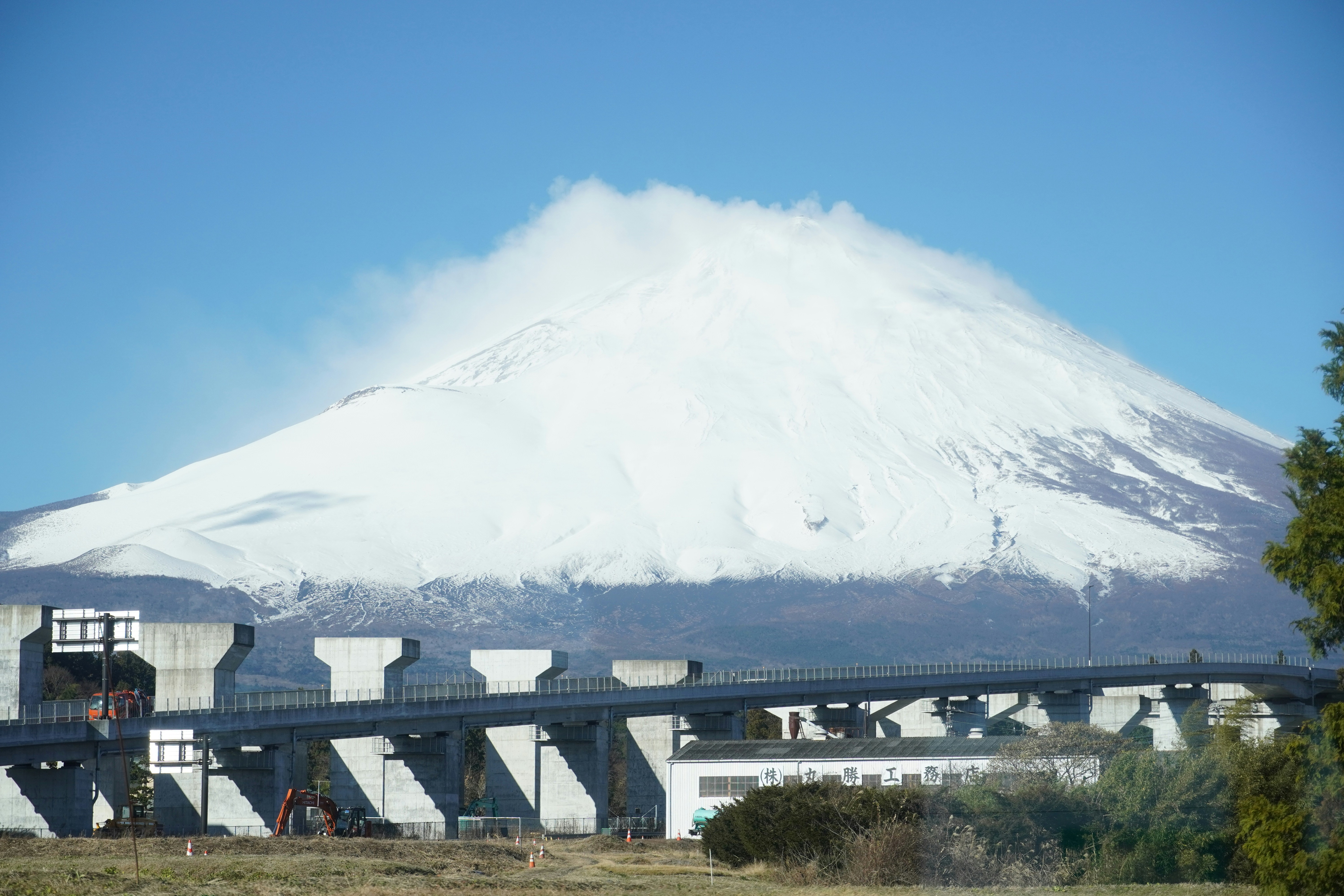 Snow-Capped Peak Over a Highway Viaduct