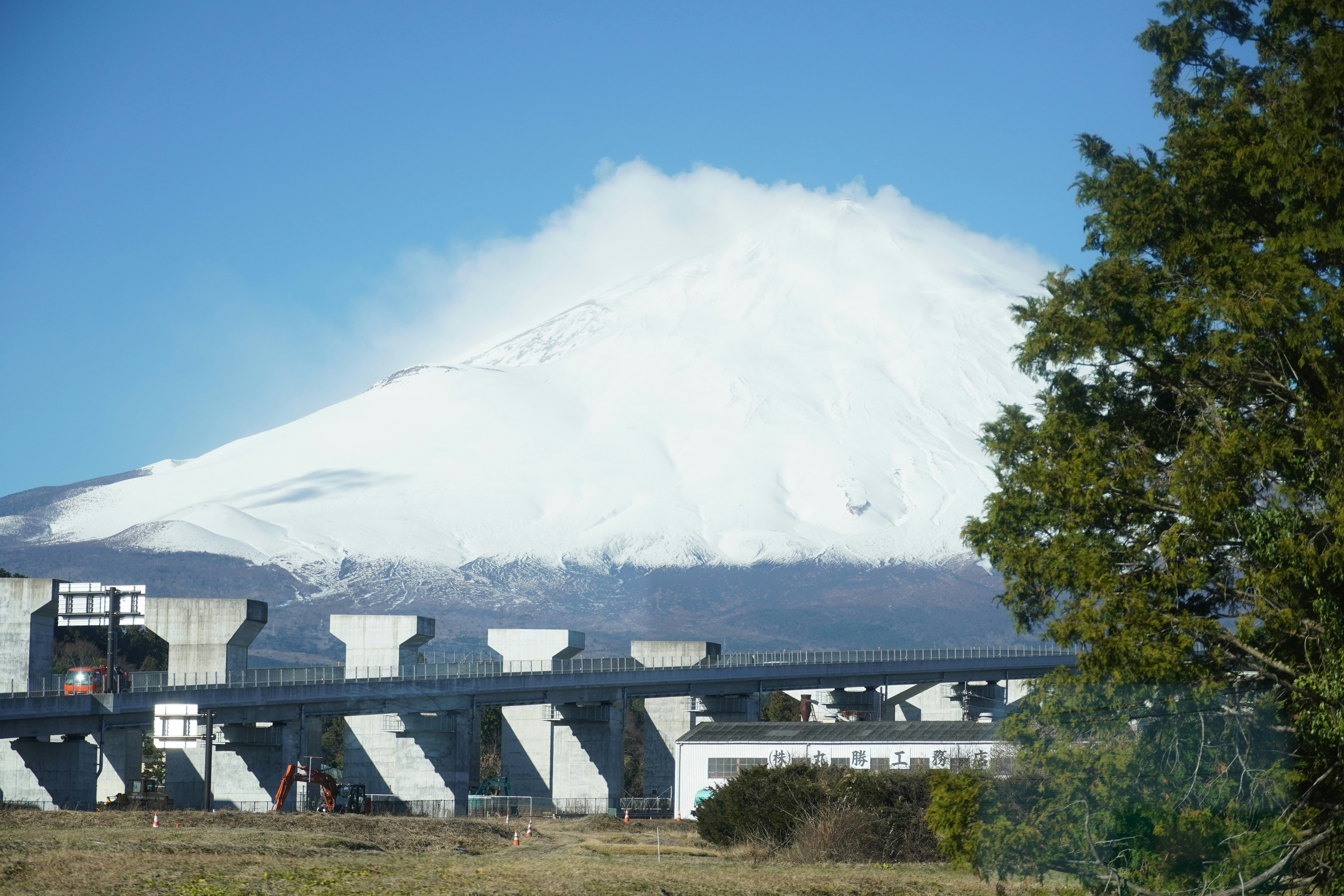 Snow-Capped Peak Over a Utility Corridor