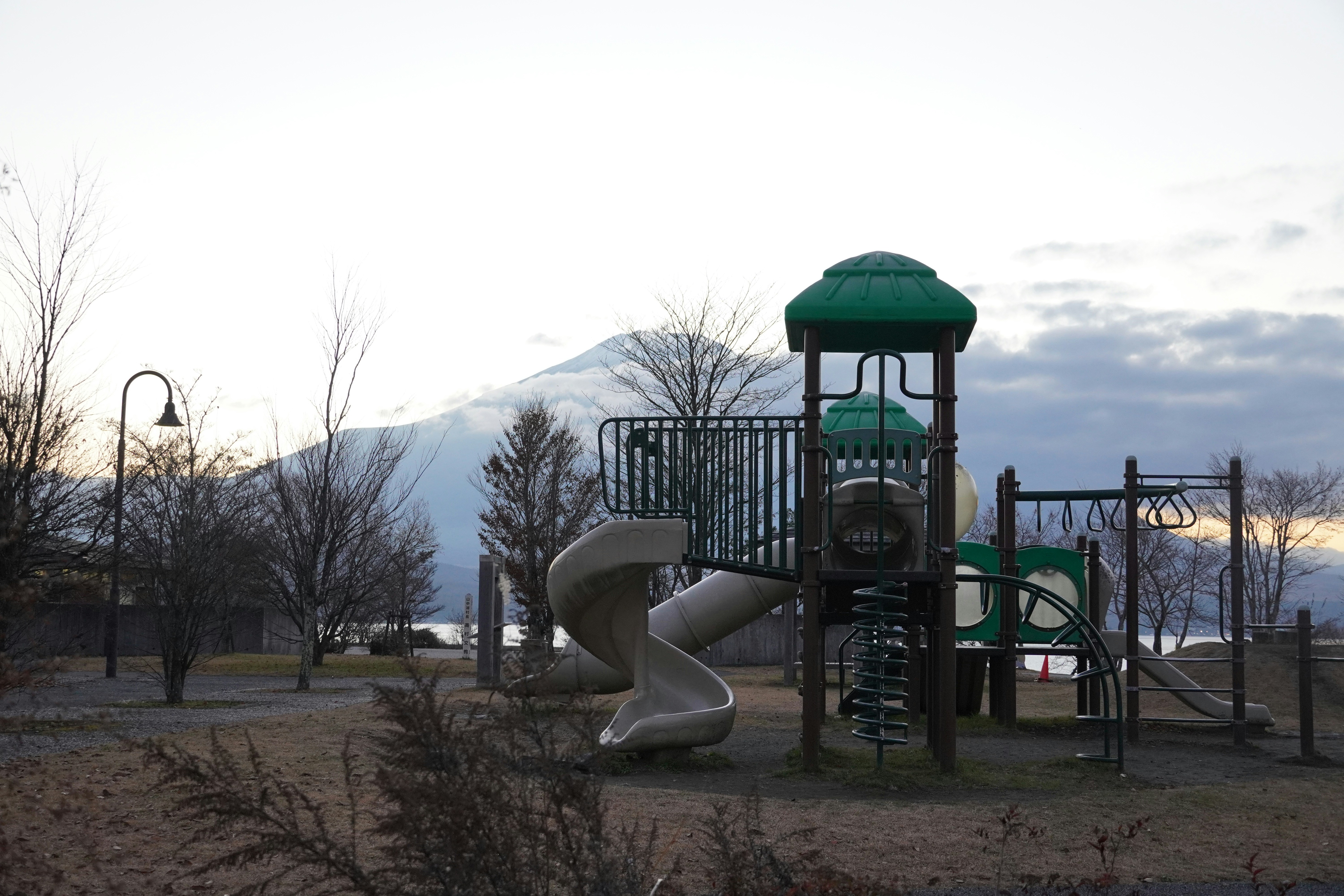 Green rooftop Play Structure Against Distant Snowy Peak