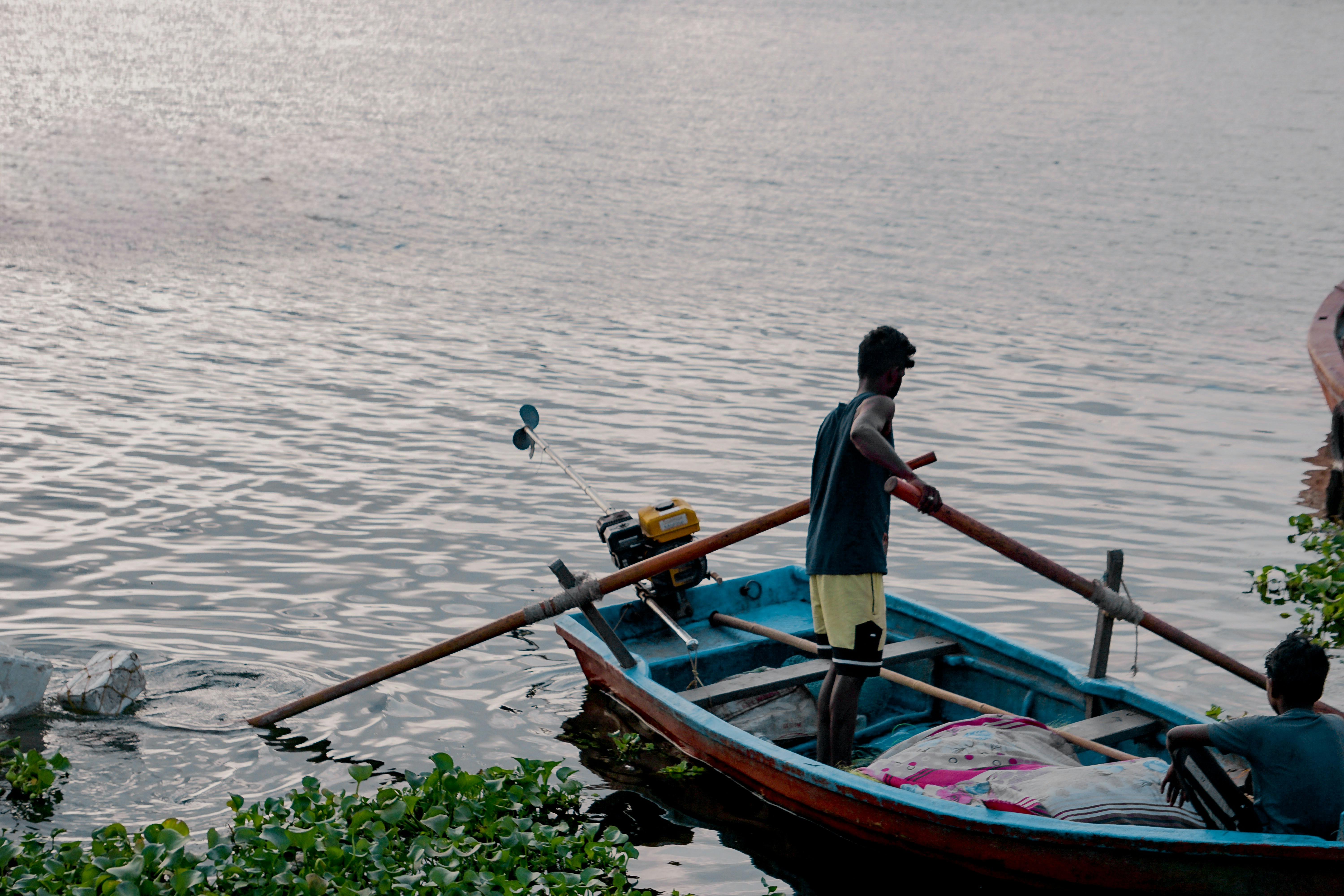 Crew on a Diminutive Boat at the Water's Edge