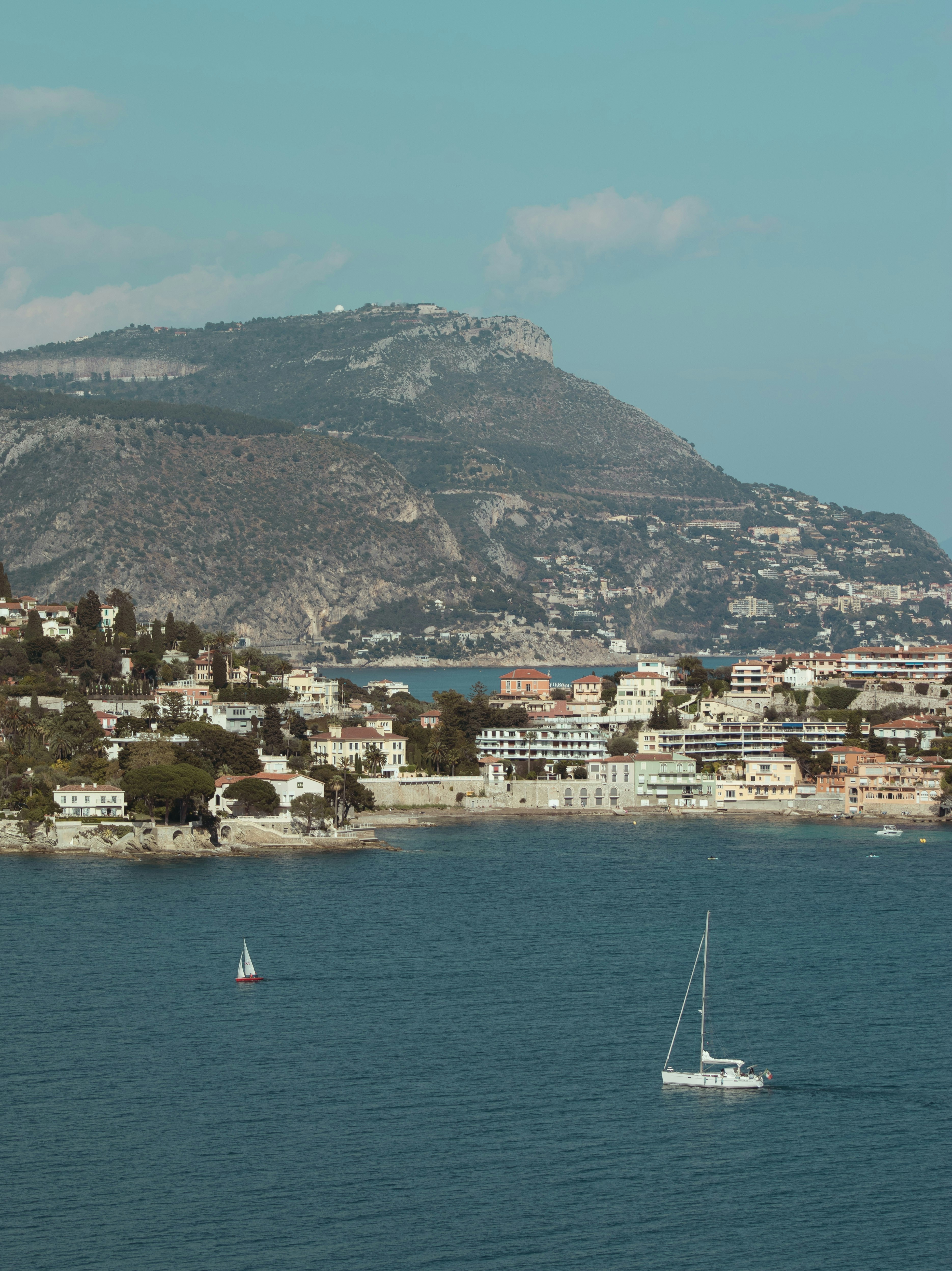 Coastal Village at the Foot of a Distant Cliff