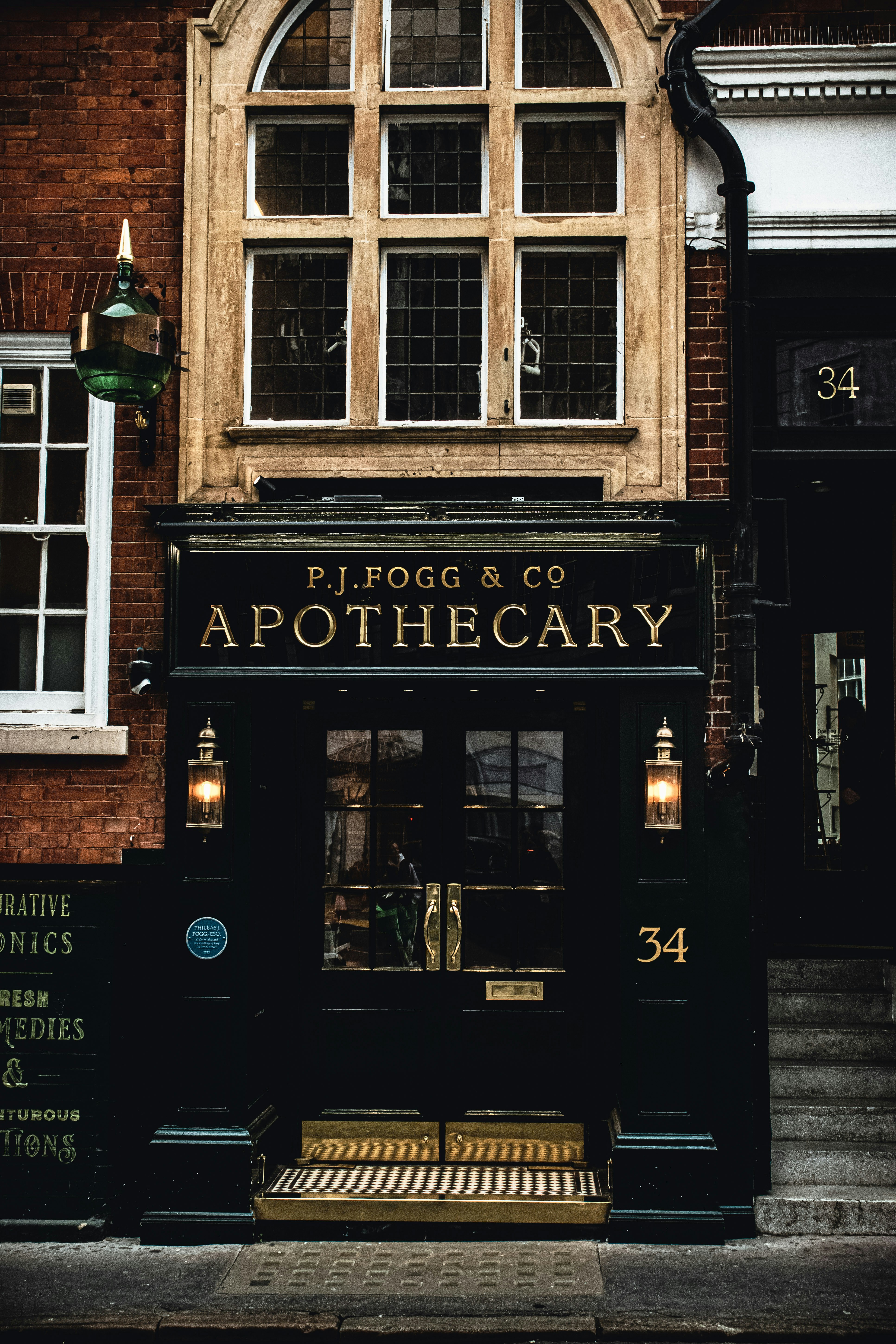 Old-World Apothecary Facade Framed by Brick and Glass