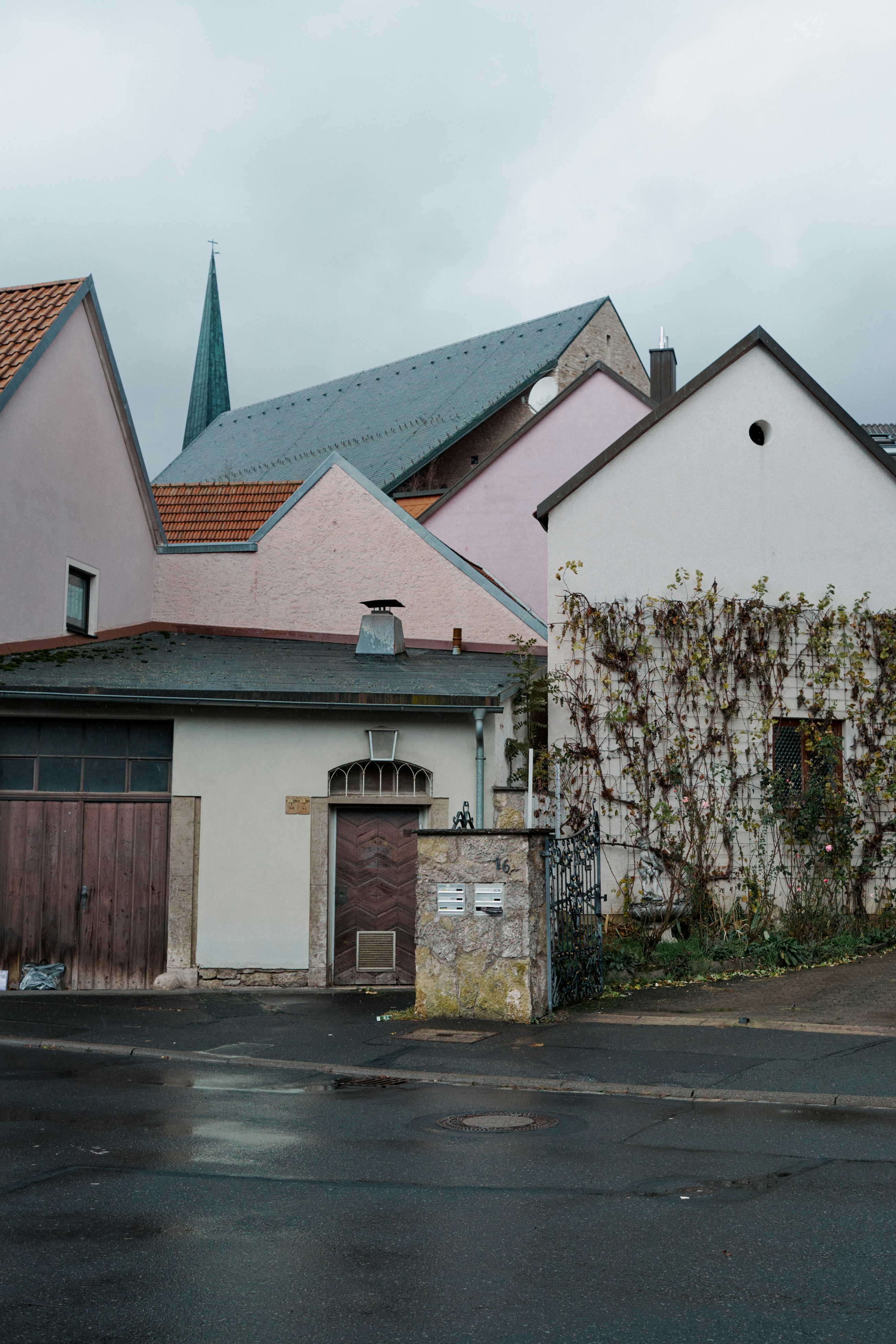 Colorful rooftops and ivy-clad wall in quiet village street