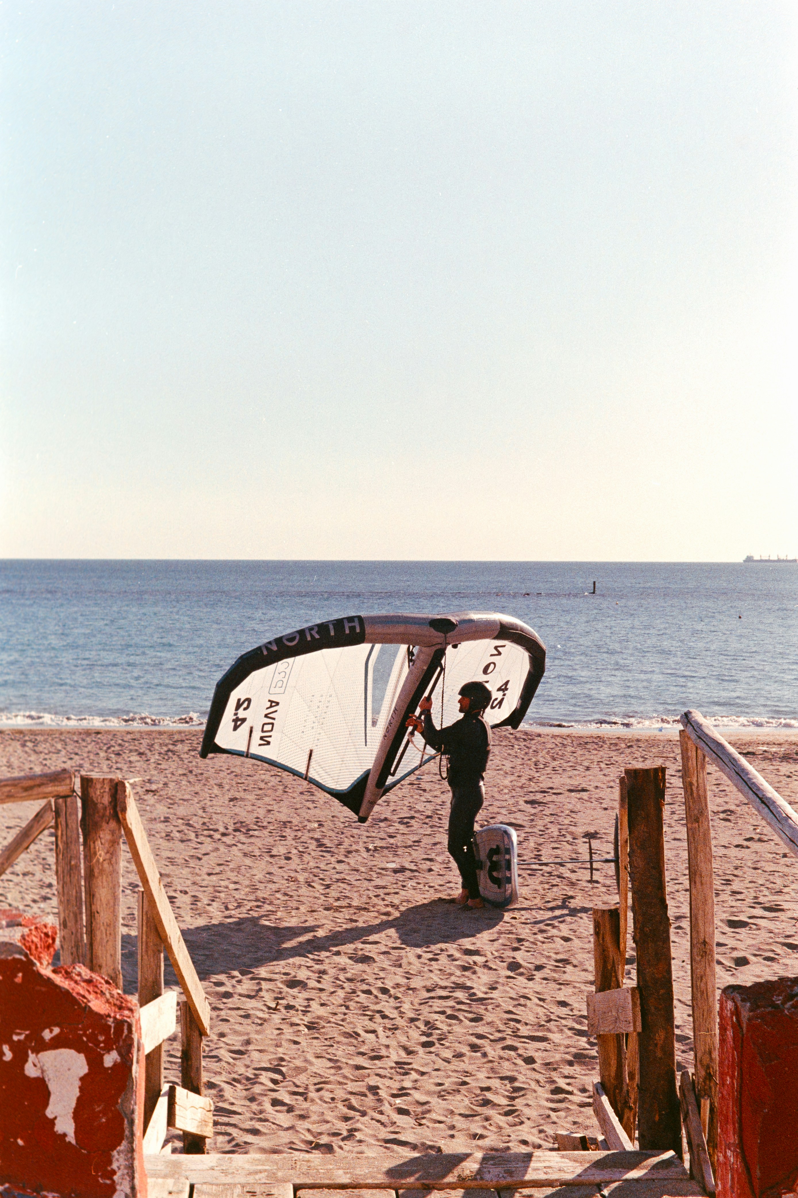 Windswept Kiteboarder Preps at a Sunny Beach