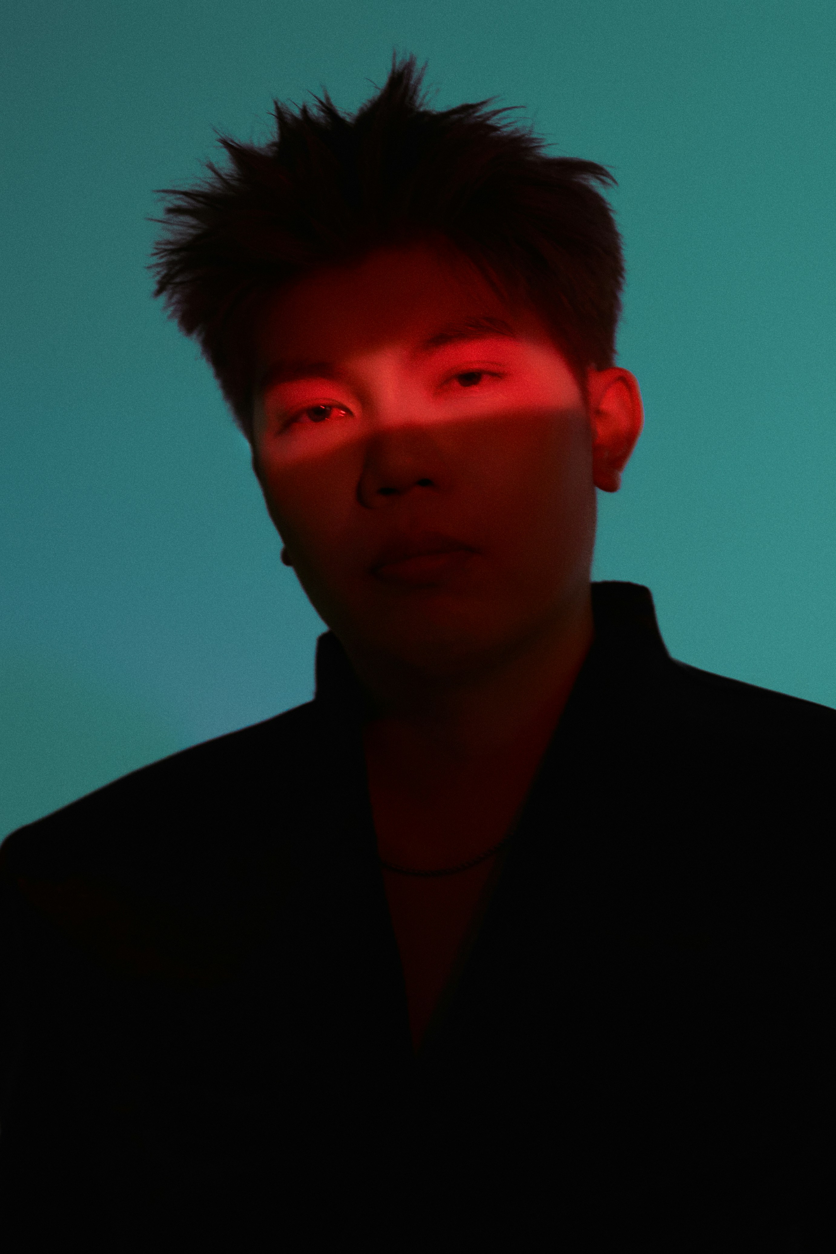 Red Light, Quiet Gaze: Silhouetted Portrait in Neon Cyan
