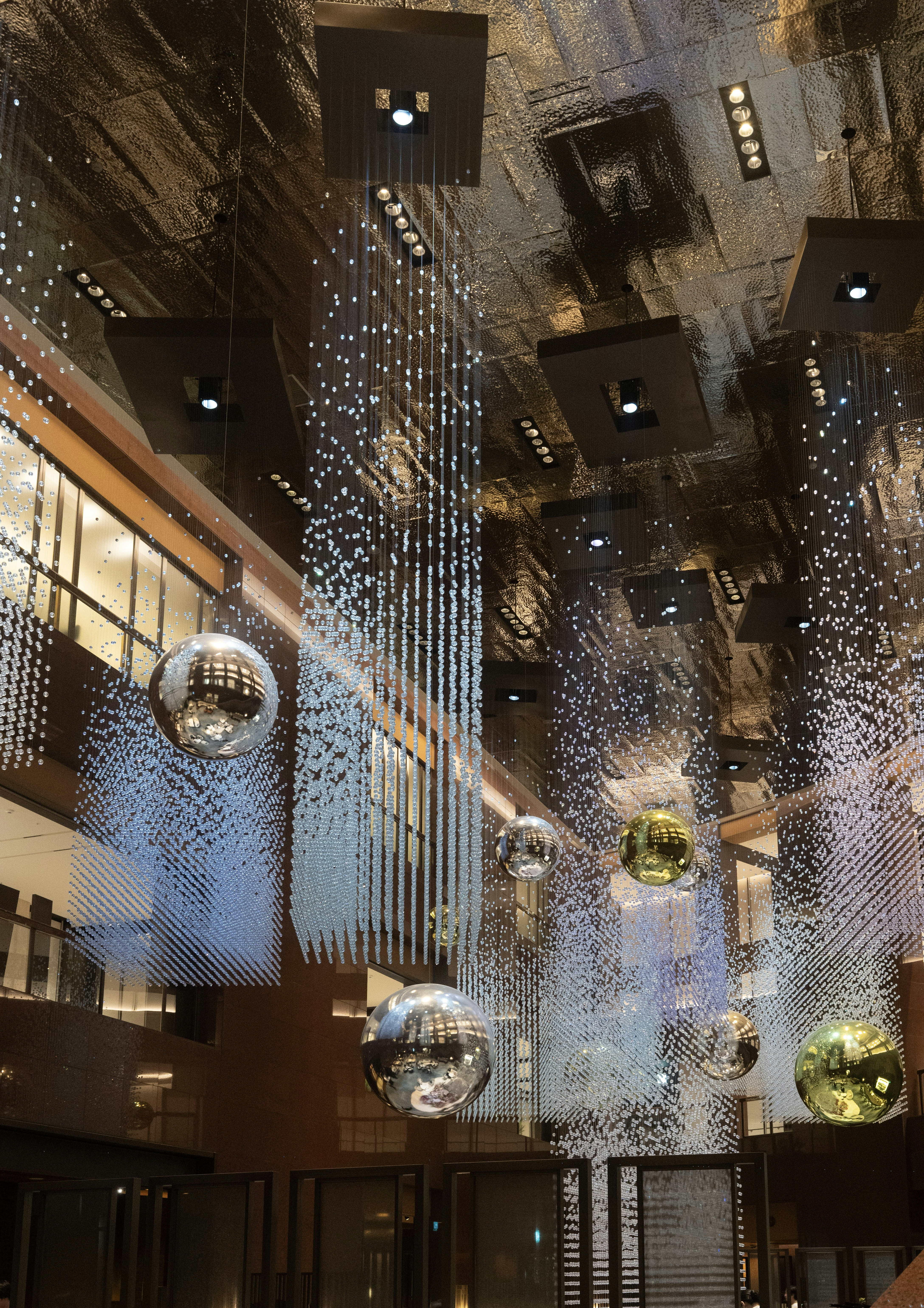 Glittering Orbs and Falling Lights in a Modern Atrium