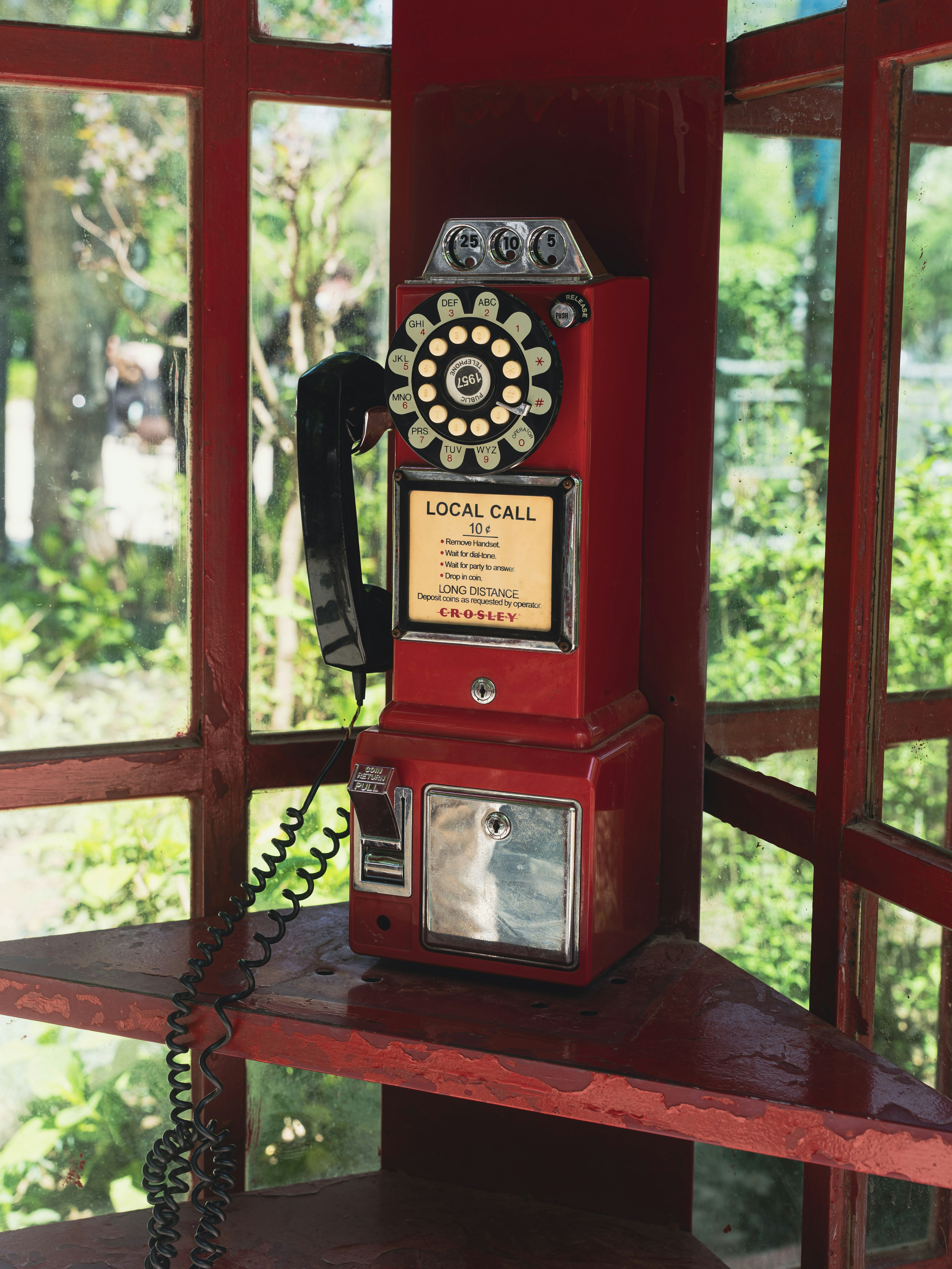 Red Payphone in a Glass-Wedged Garden Cabin