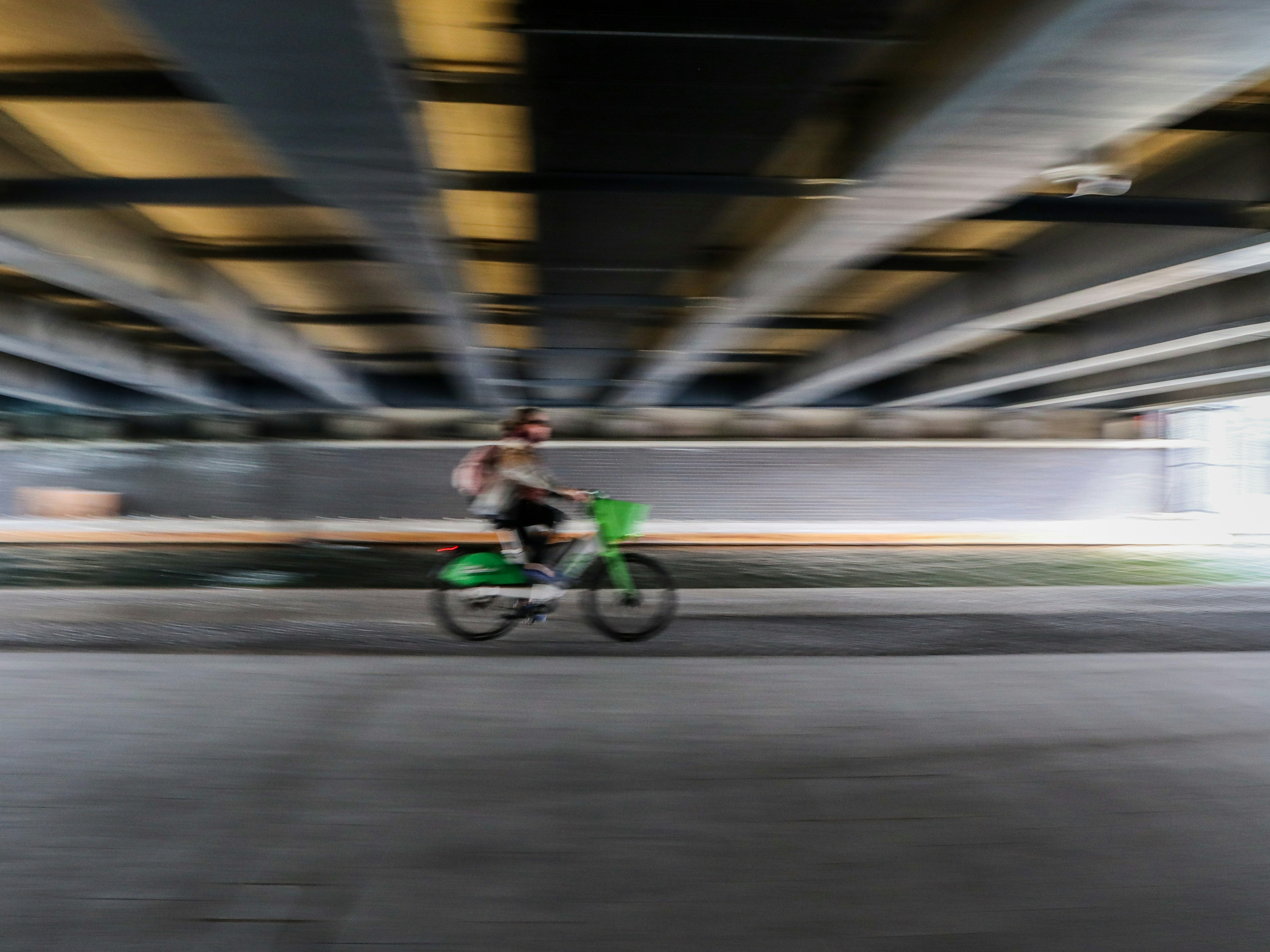 Under the Overpass: Moto Rider in a Blur of Motion