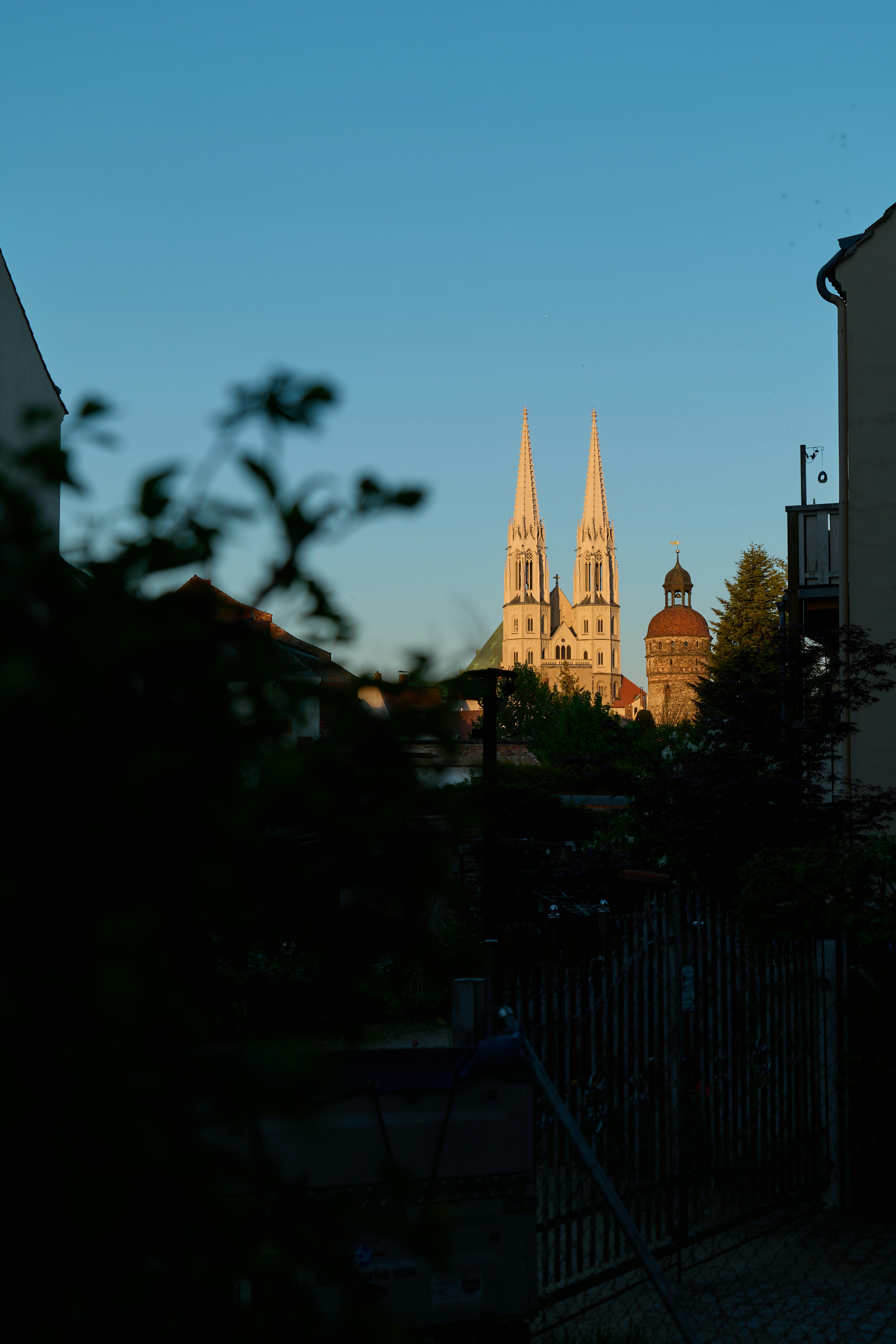 Twin Spires in the Golden Hour: Cathedral Backlit Above a Quiet Canal