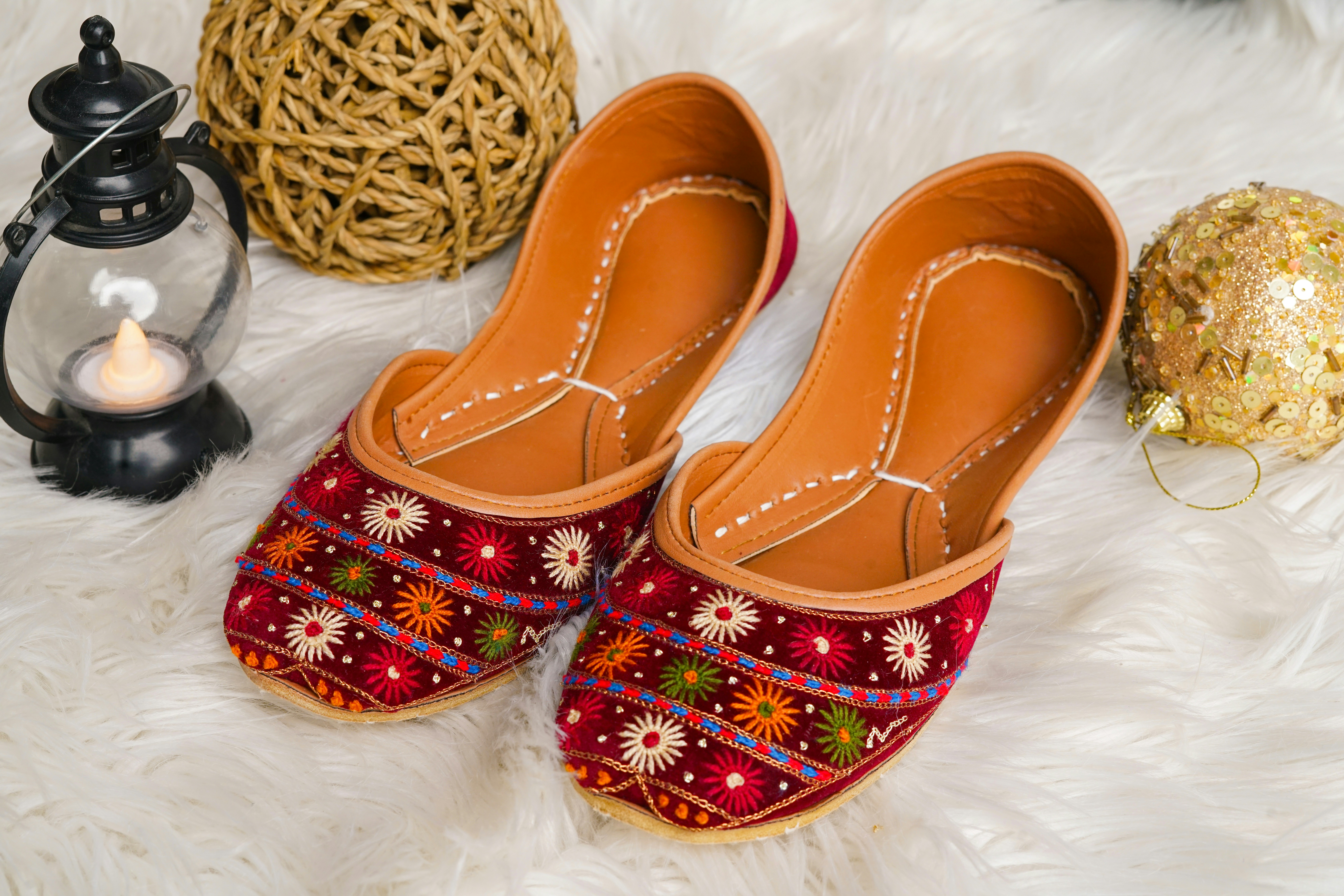 Embroidered Steps: Colorful Slippers Resting on Plush White Floor