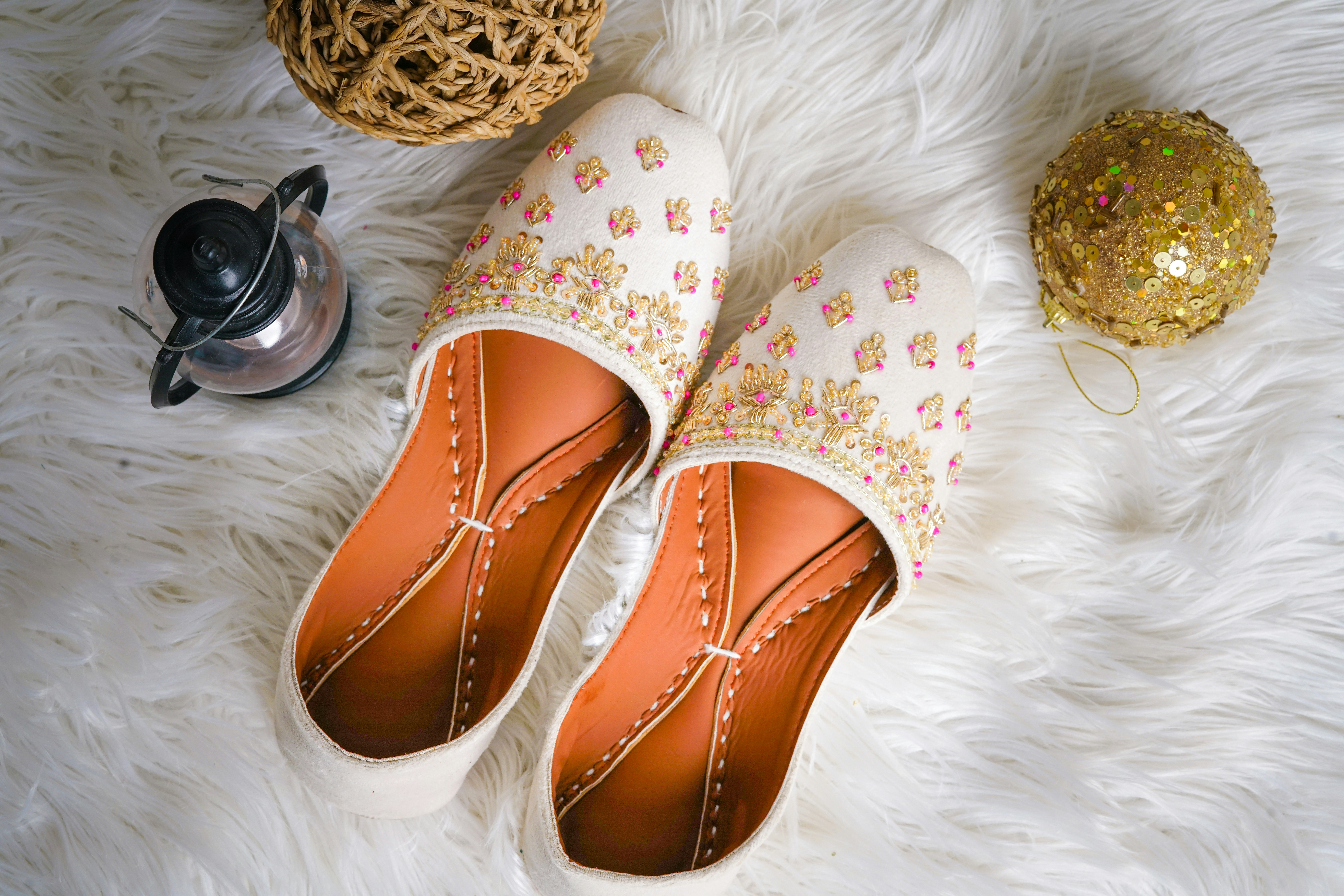 Floral Embroidered Slippers Nestled on Soft Frosted White