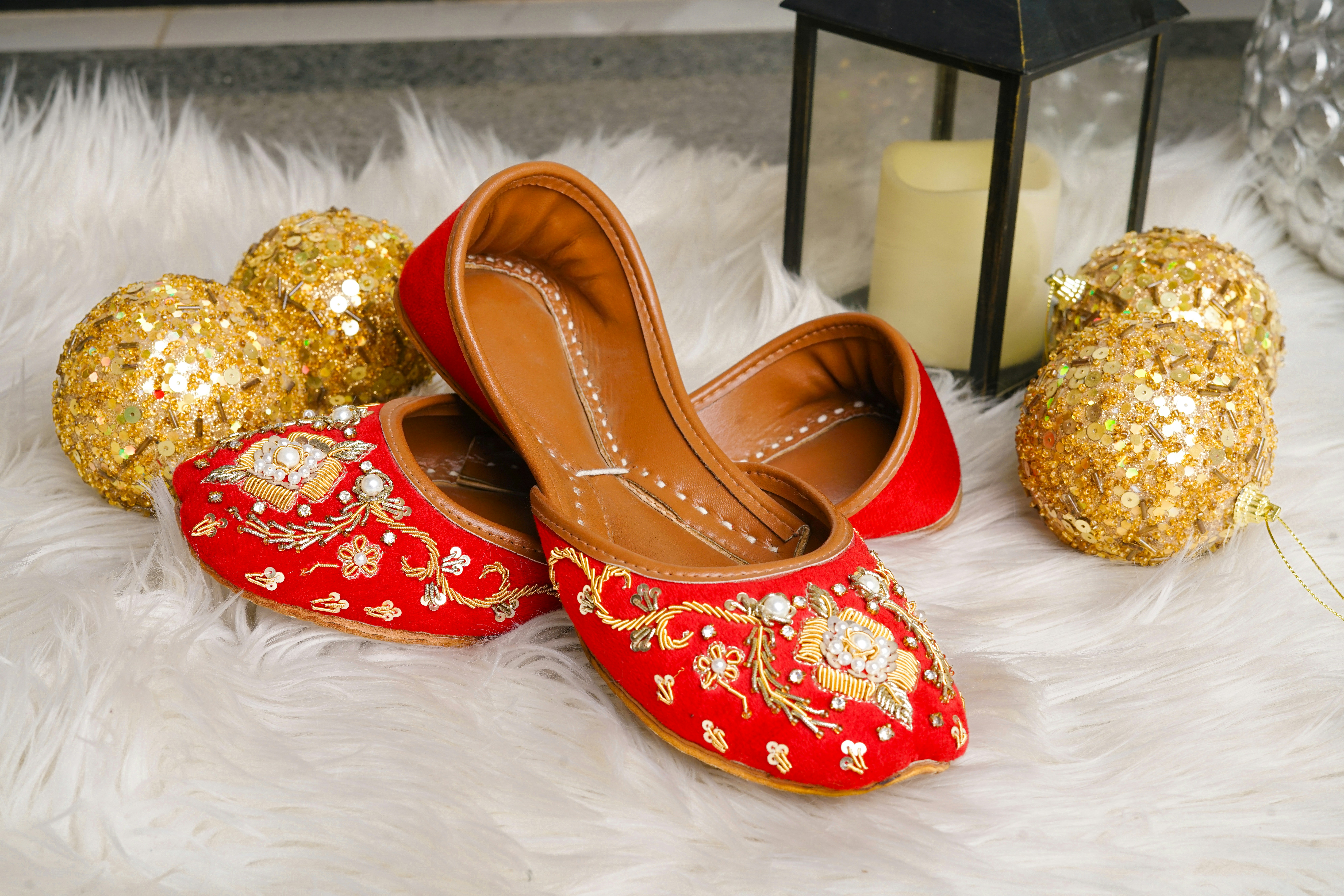Red Embroidered Flats Resting on a Plush Snowy Mantle