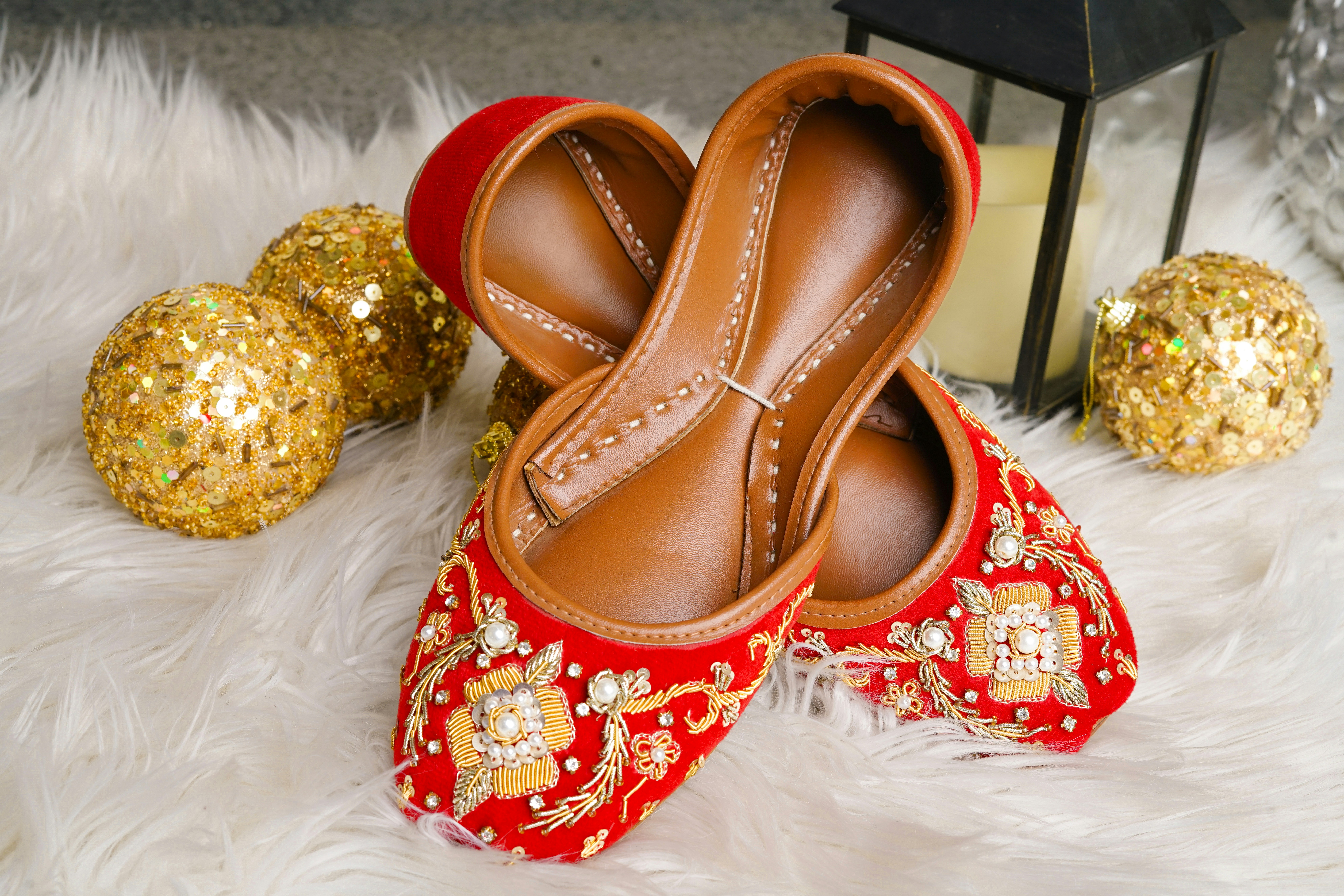Embroidered Red Flats Resting on Plush Snow-like Fabric