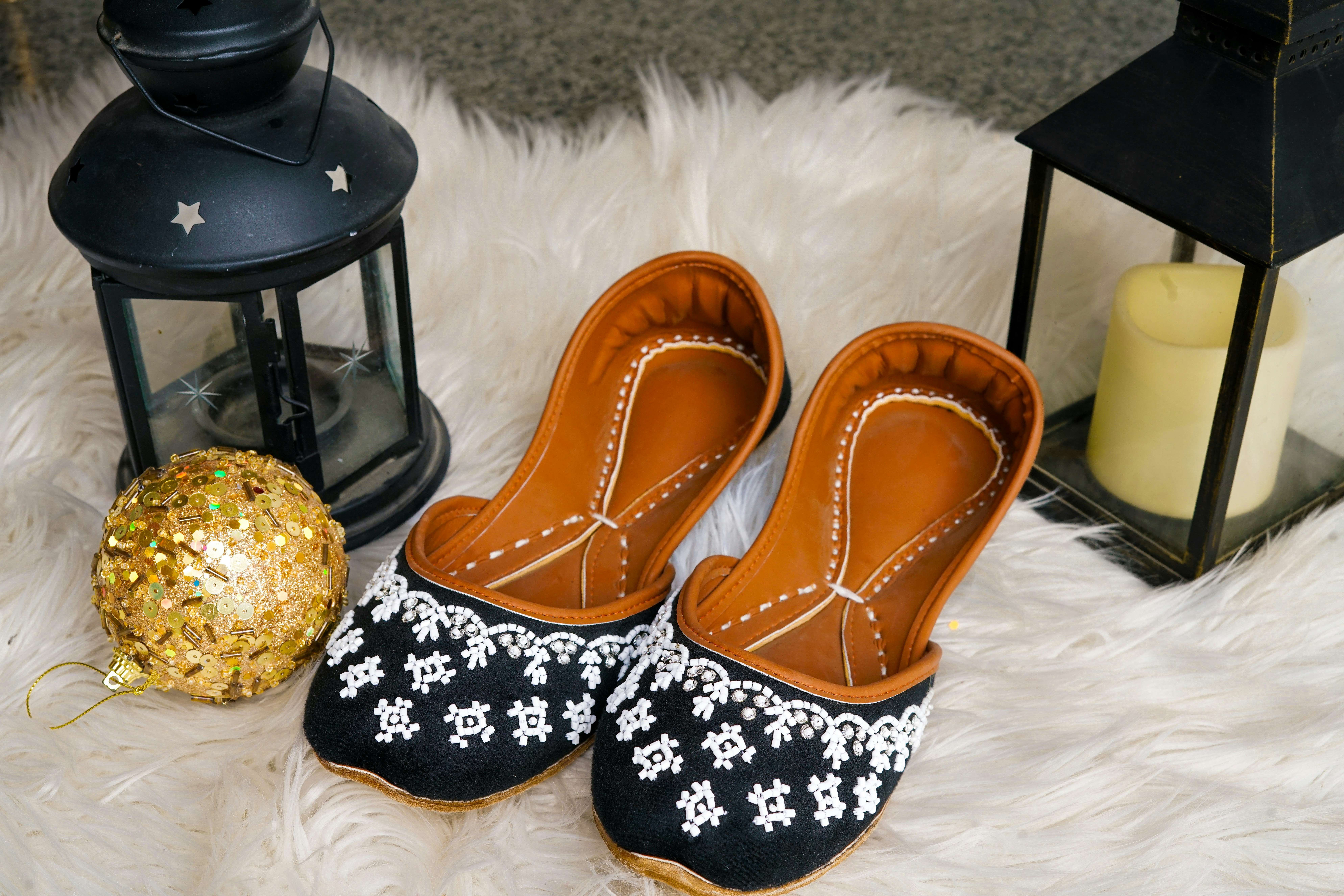 Embroidered Mocs Beside Holiday Lanterns