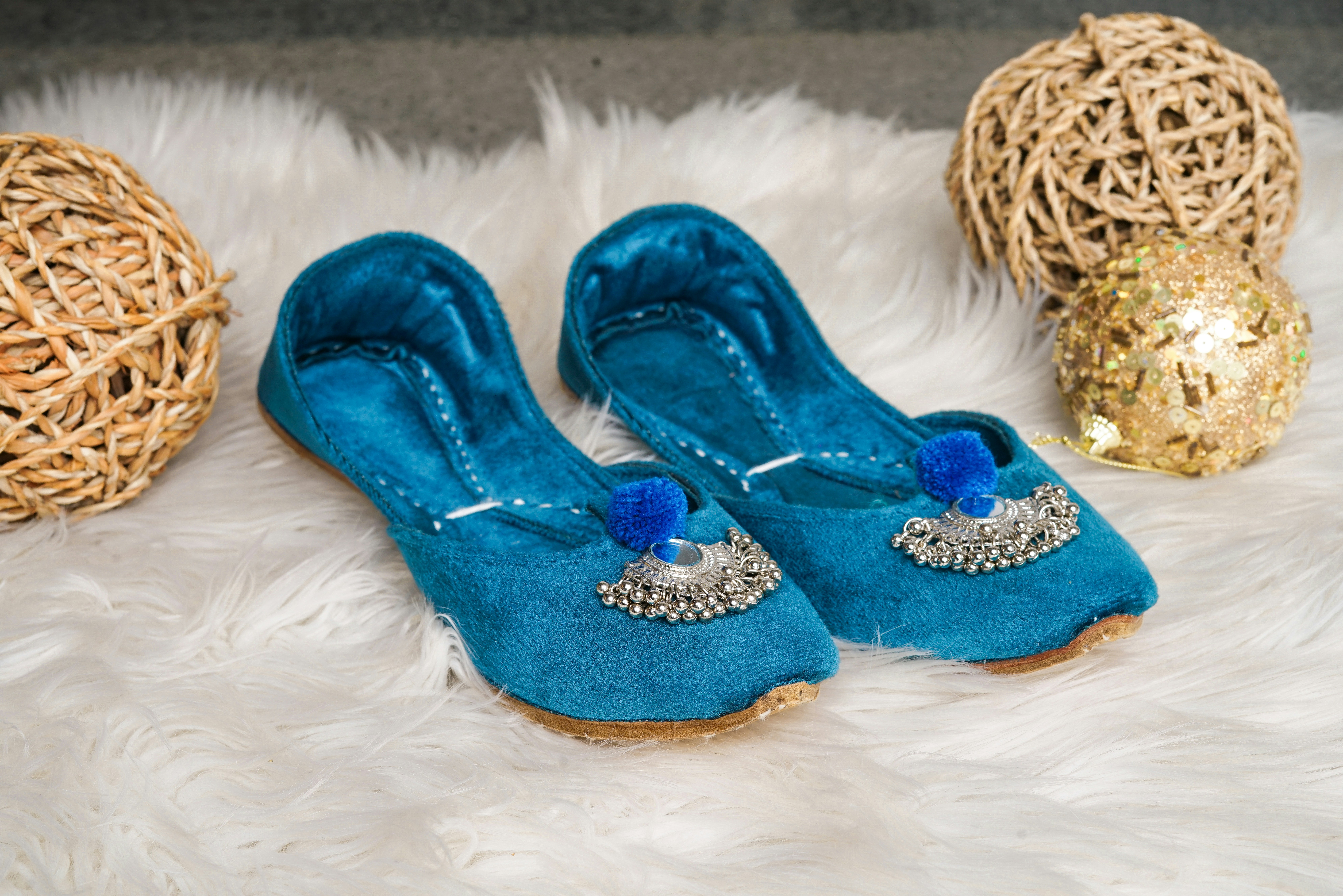 Cerulean slippers resting on a snowy velvet stage