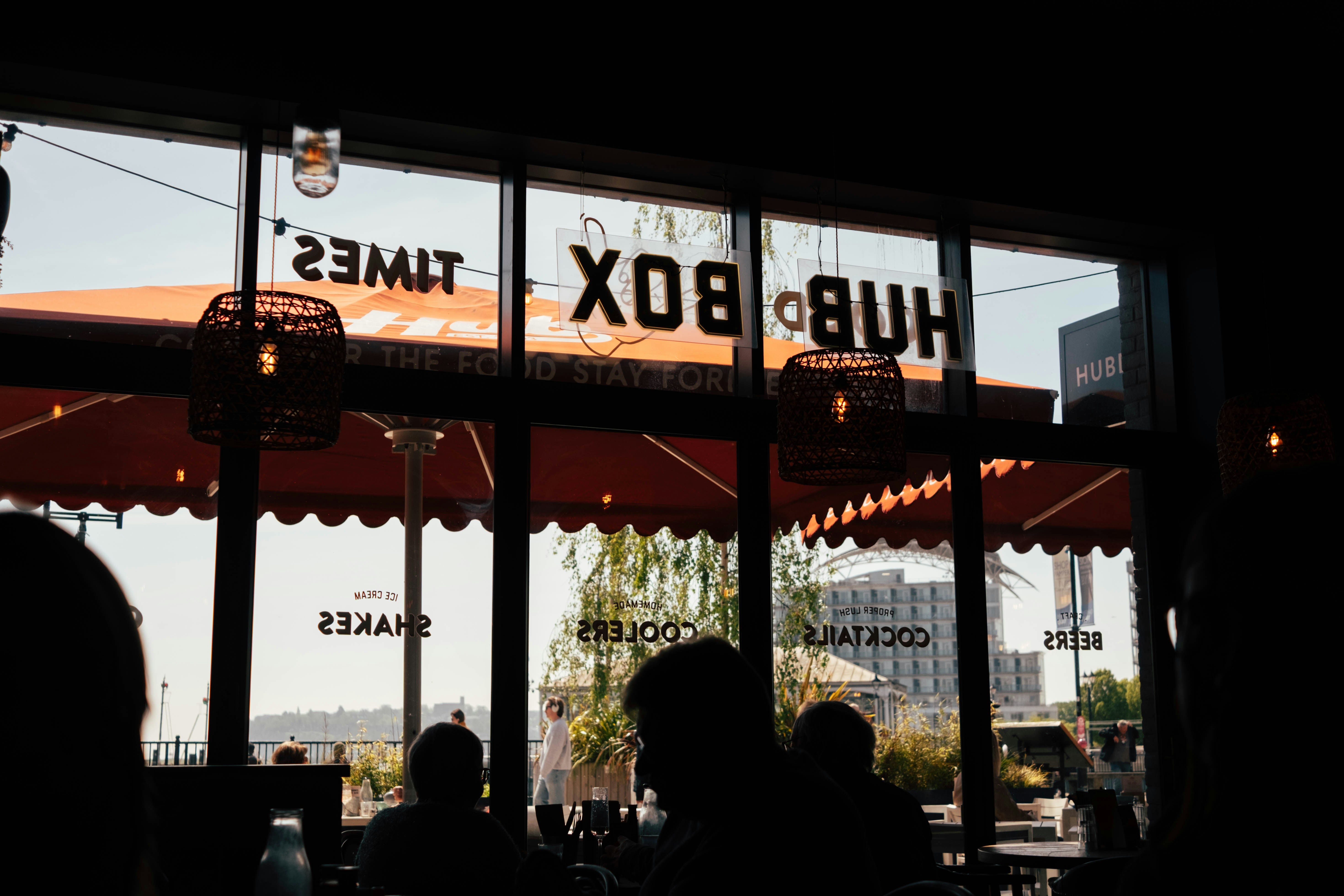Sunlit Glass and Shadowed Interior at the Hub Box Café
