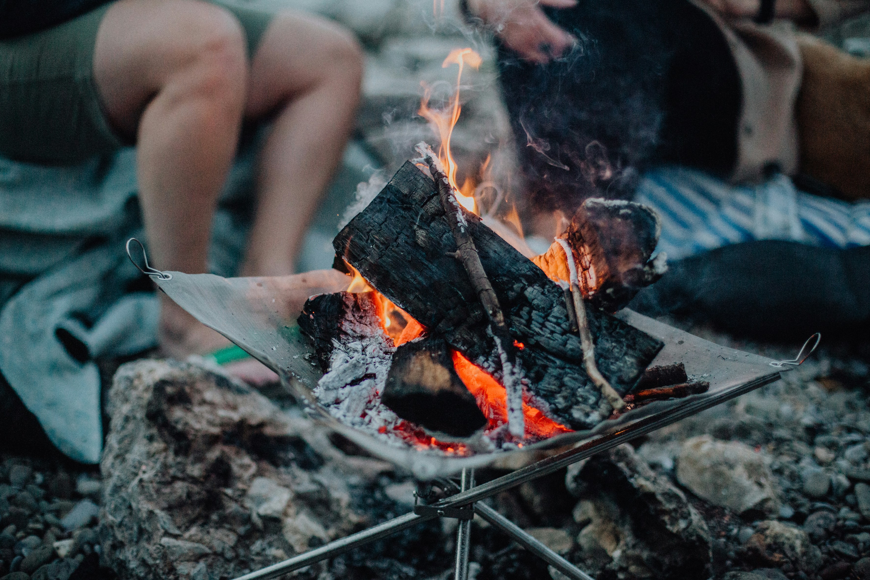 Firelight Convergence: Friends Gathered Around a Campfire