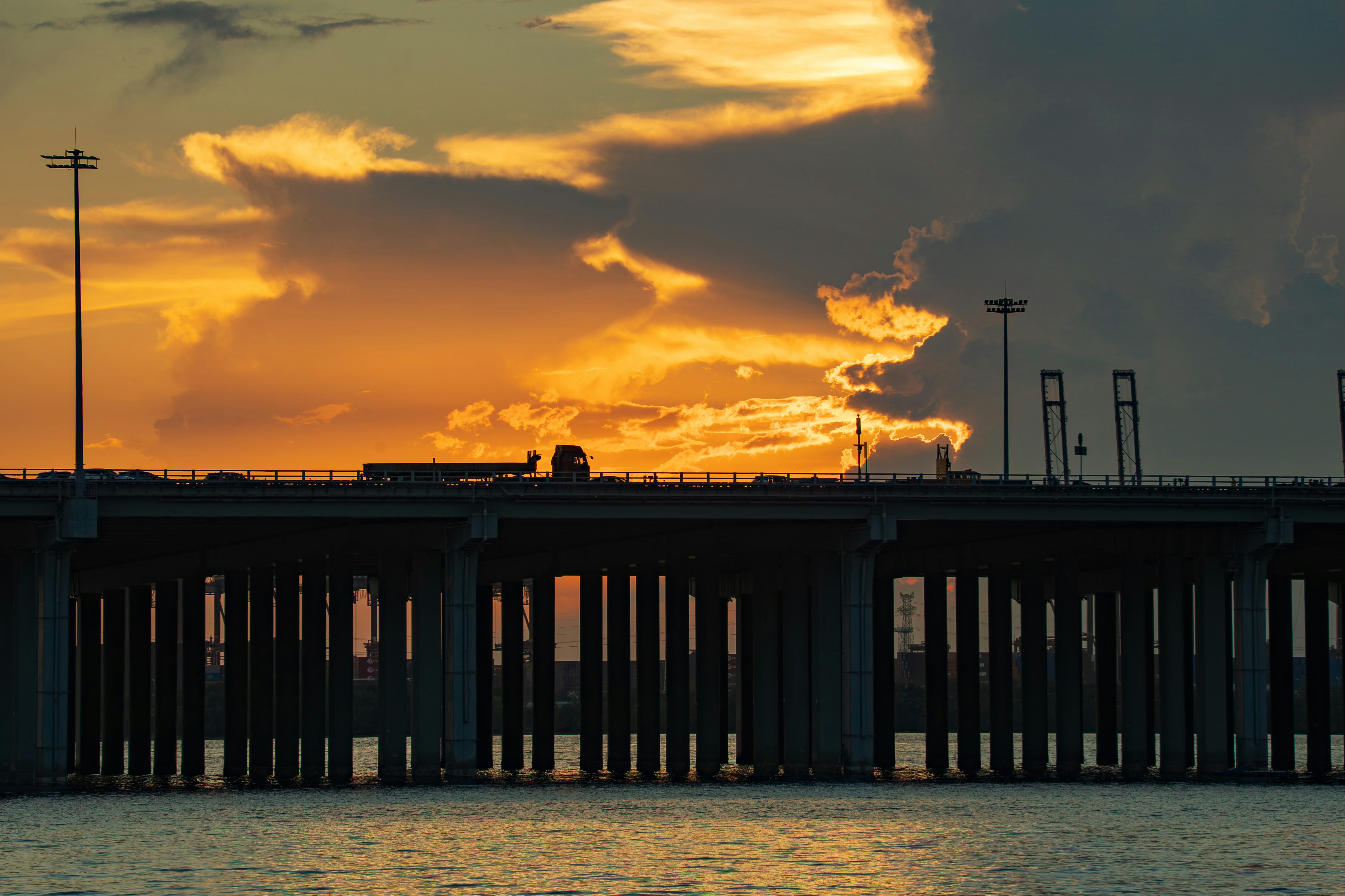 Sunset over the Pier: silhouette of support columns against a fiery sky