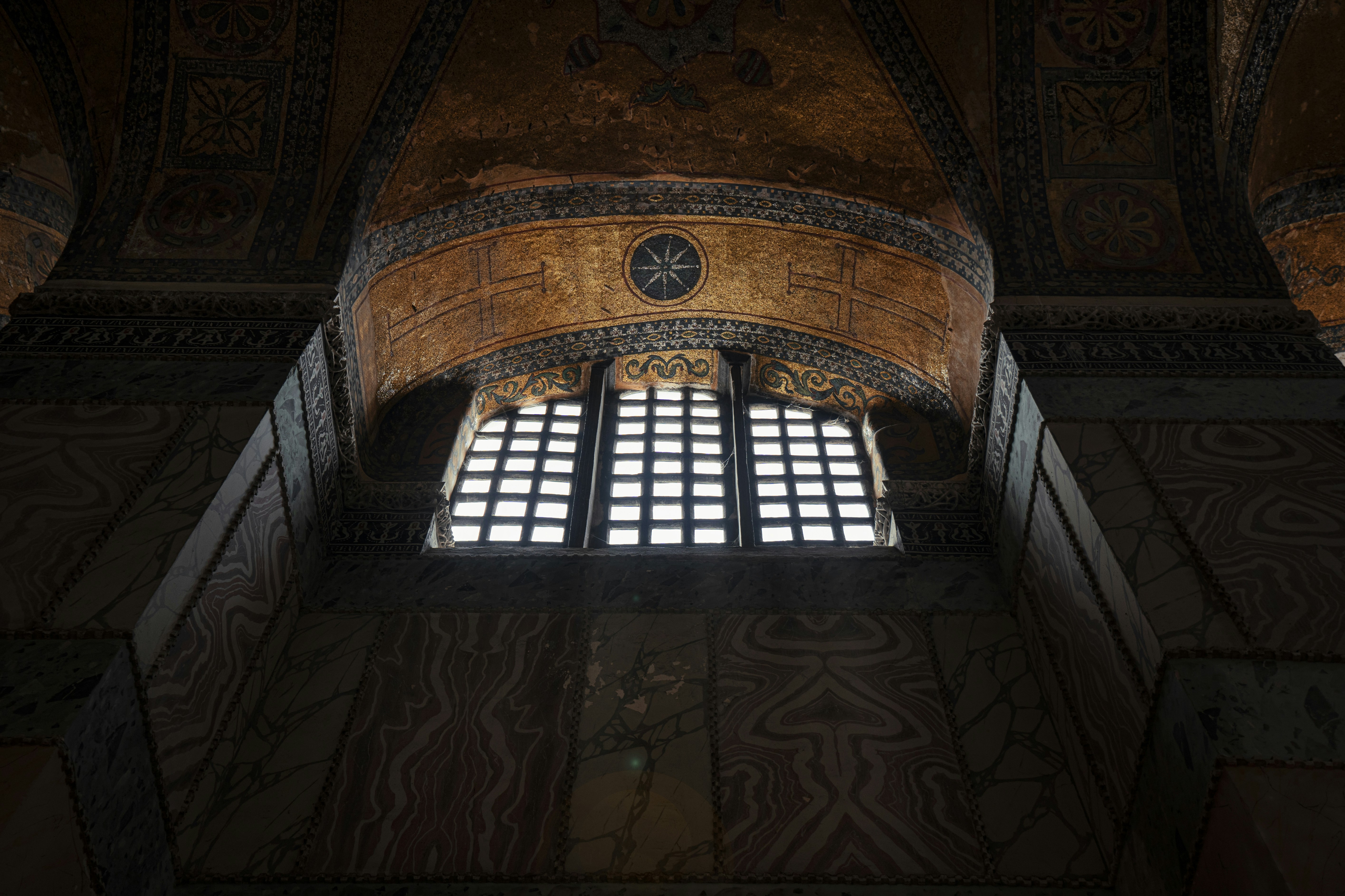 Darkened Nave with Stained Window: Echoes of Marble and Patterned Walls