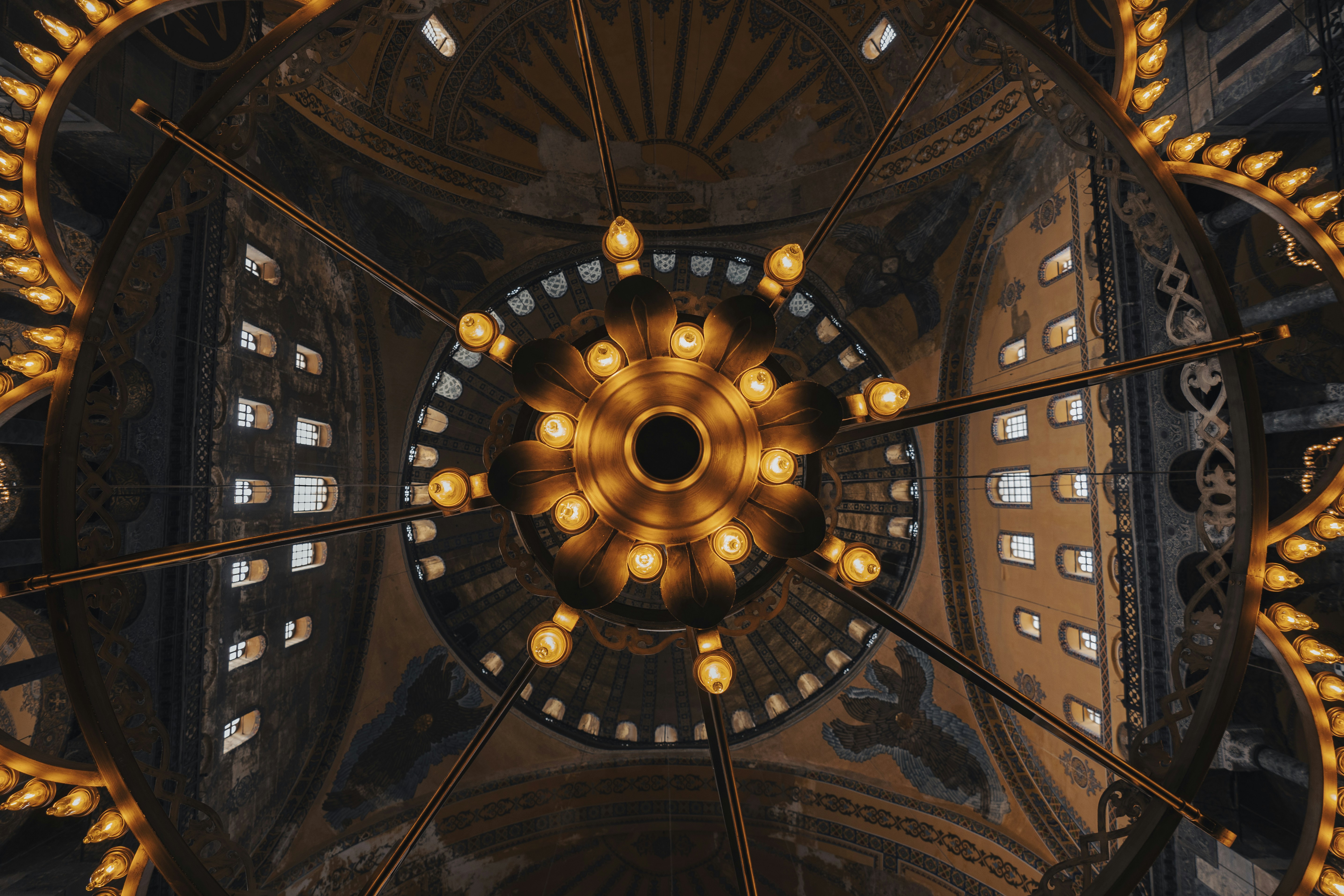 Divine Geometry: Golden Chandelier Centered in Ornate Dome