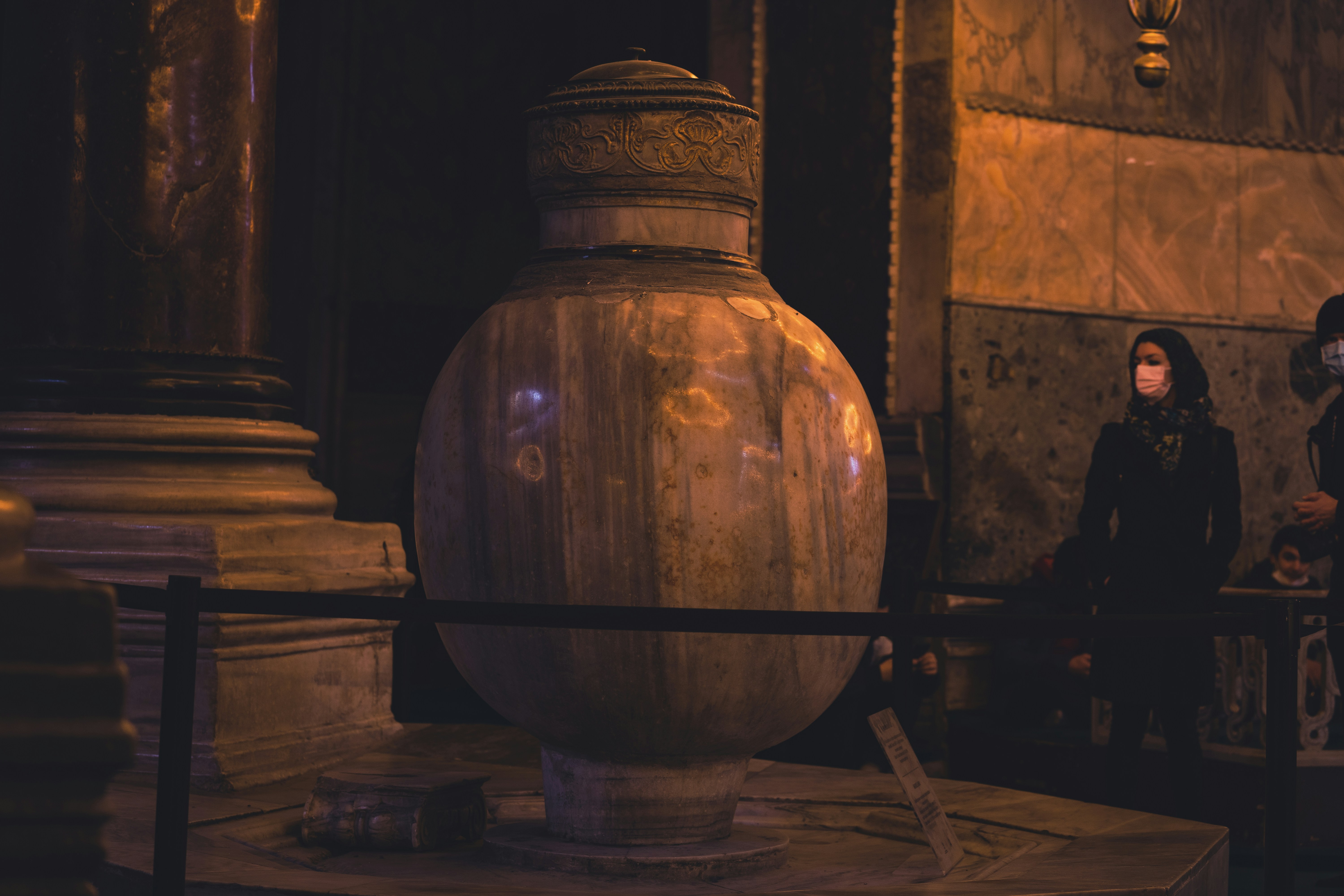 Ancient Urn Under Warm Cathedral Light