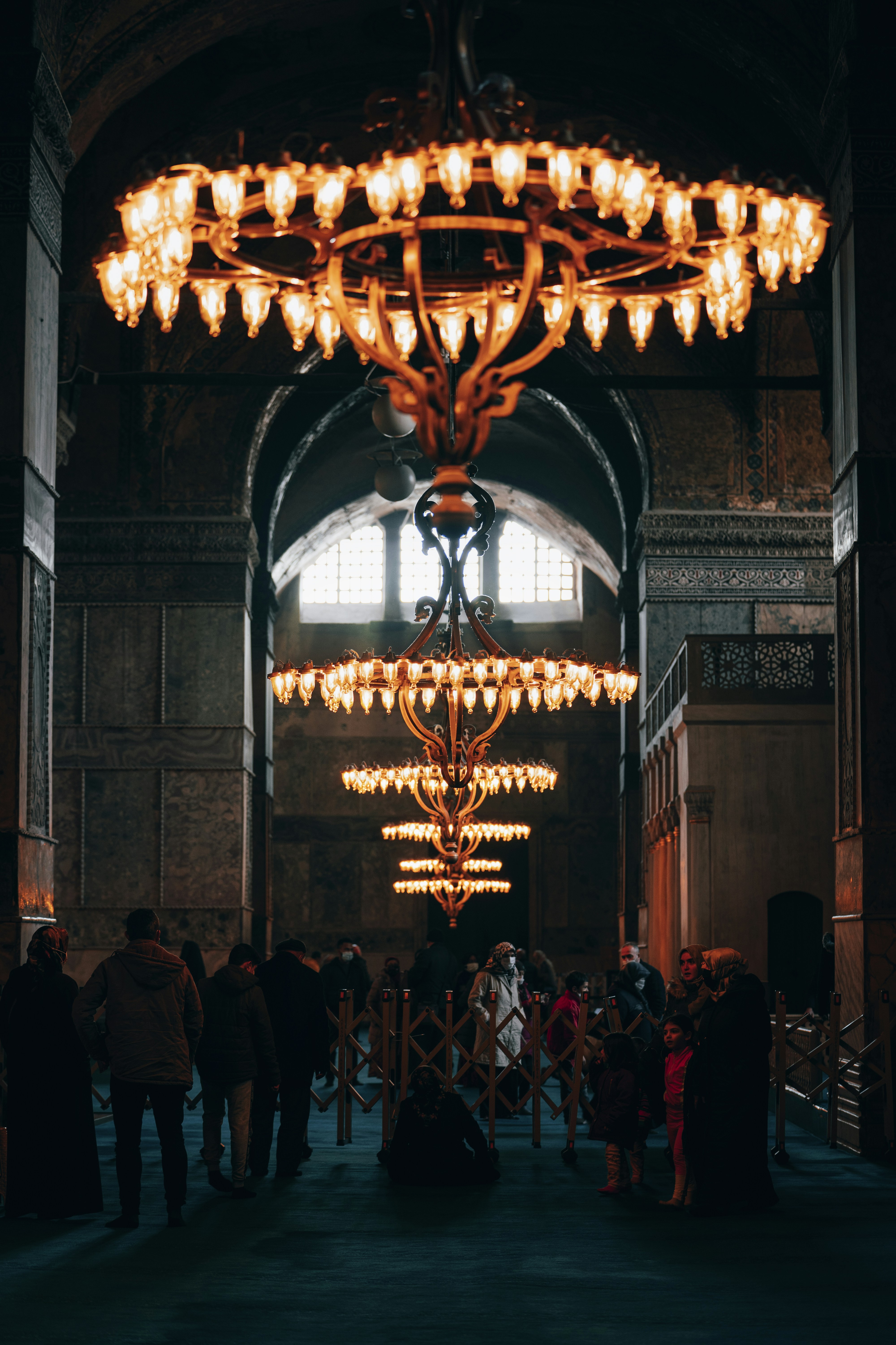 Chandeliers Guiding the Silent Crowd in a Historic Hall