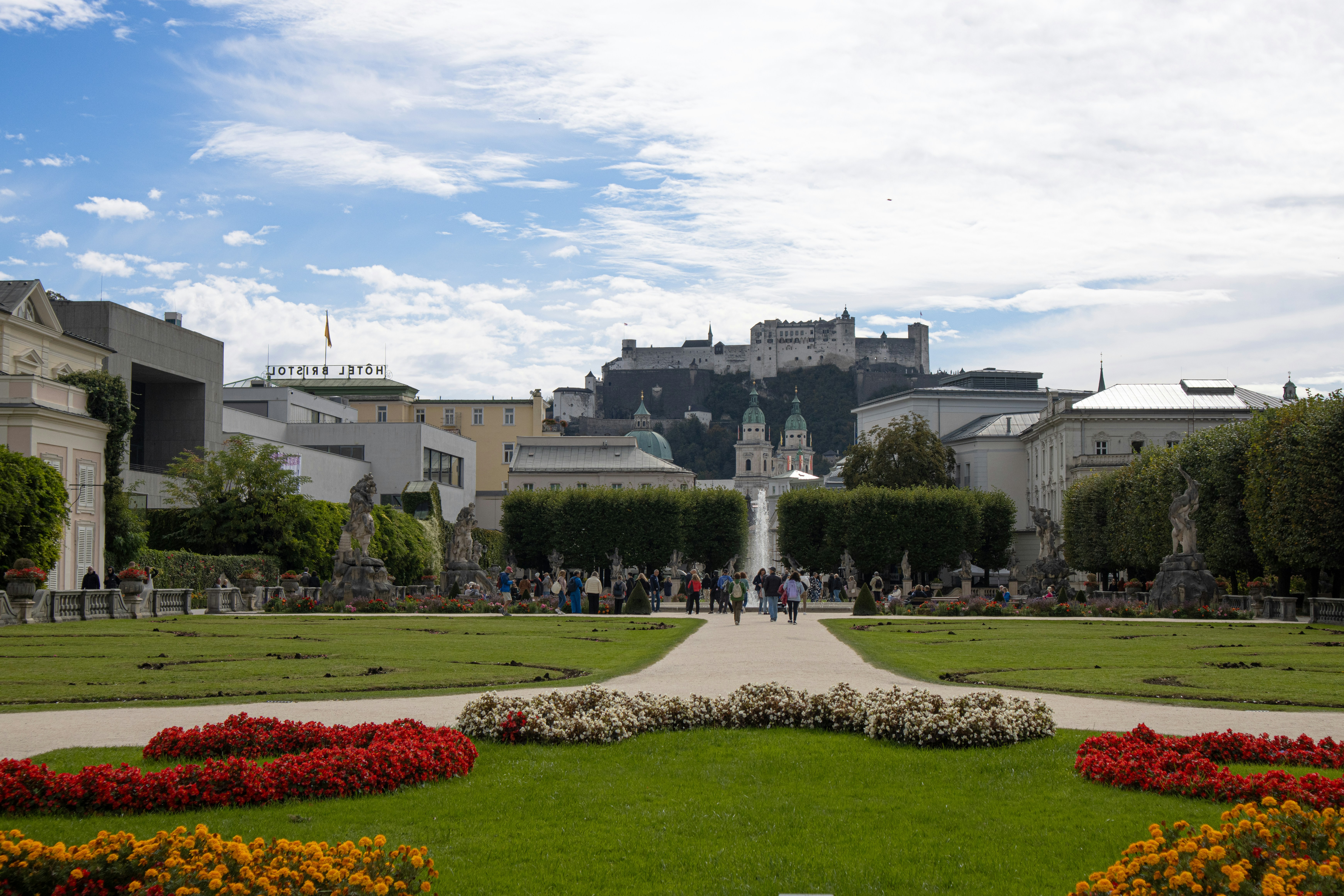 Aligned Avenue: A European city garden leading toward a distant fortress
