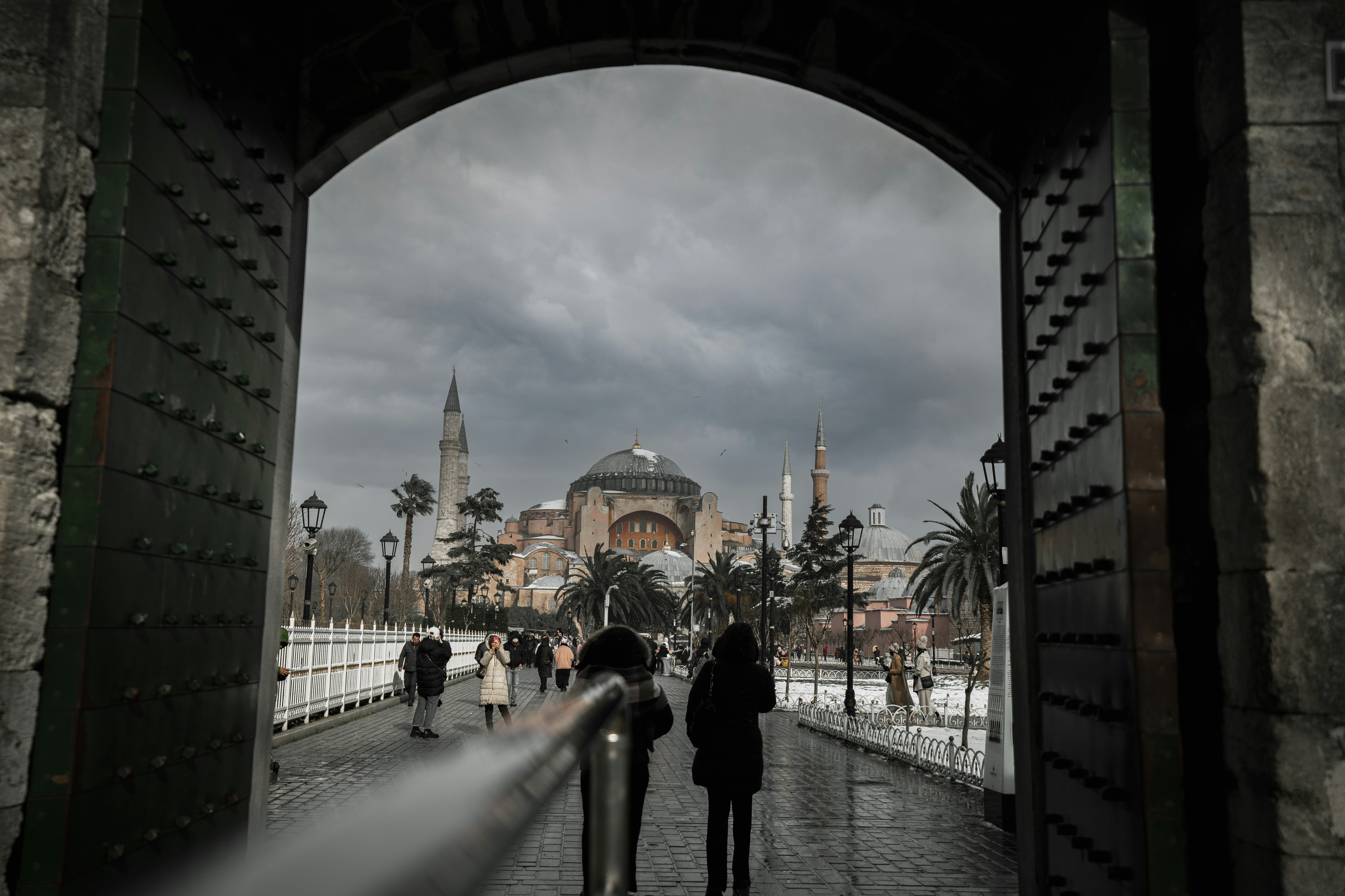 Gateway to Hagia Sophia: View Through the Arch with Rain-Slicked Courtyard
