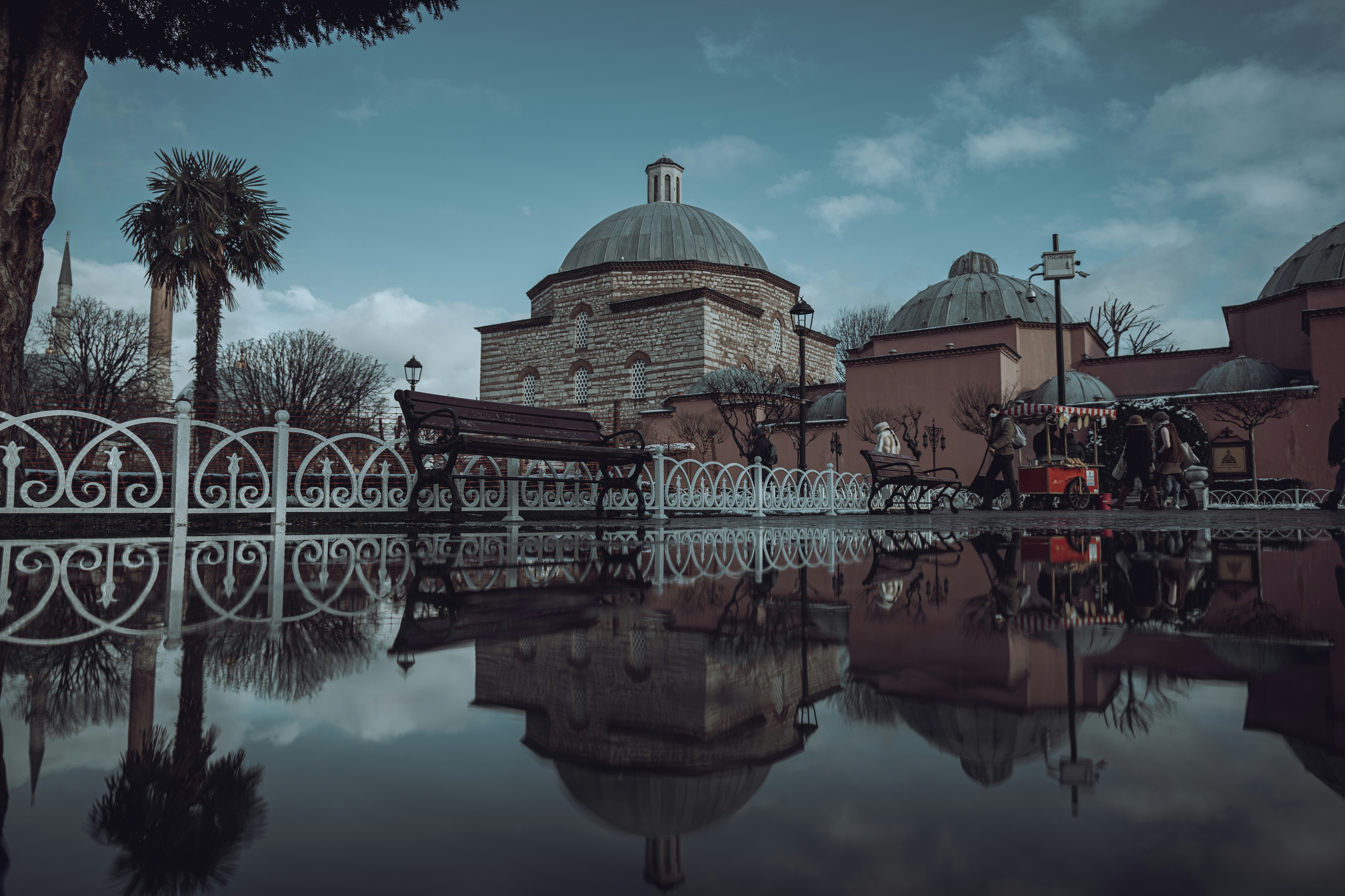 Reflections of a Dome: A Tranquil Courtyard Beneath Clouded Skies