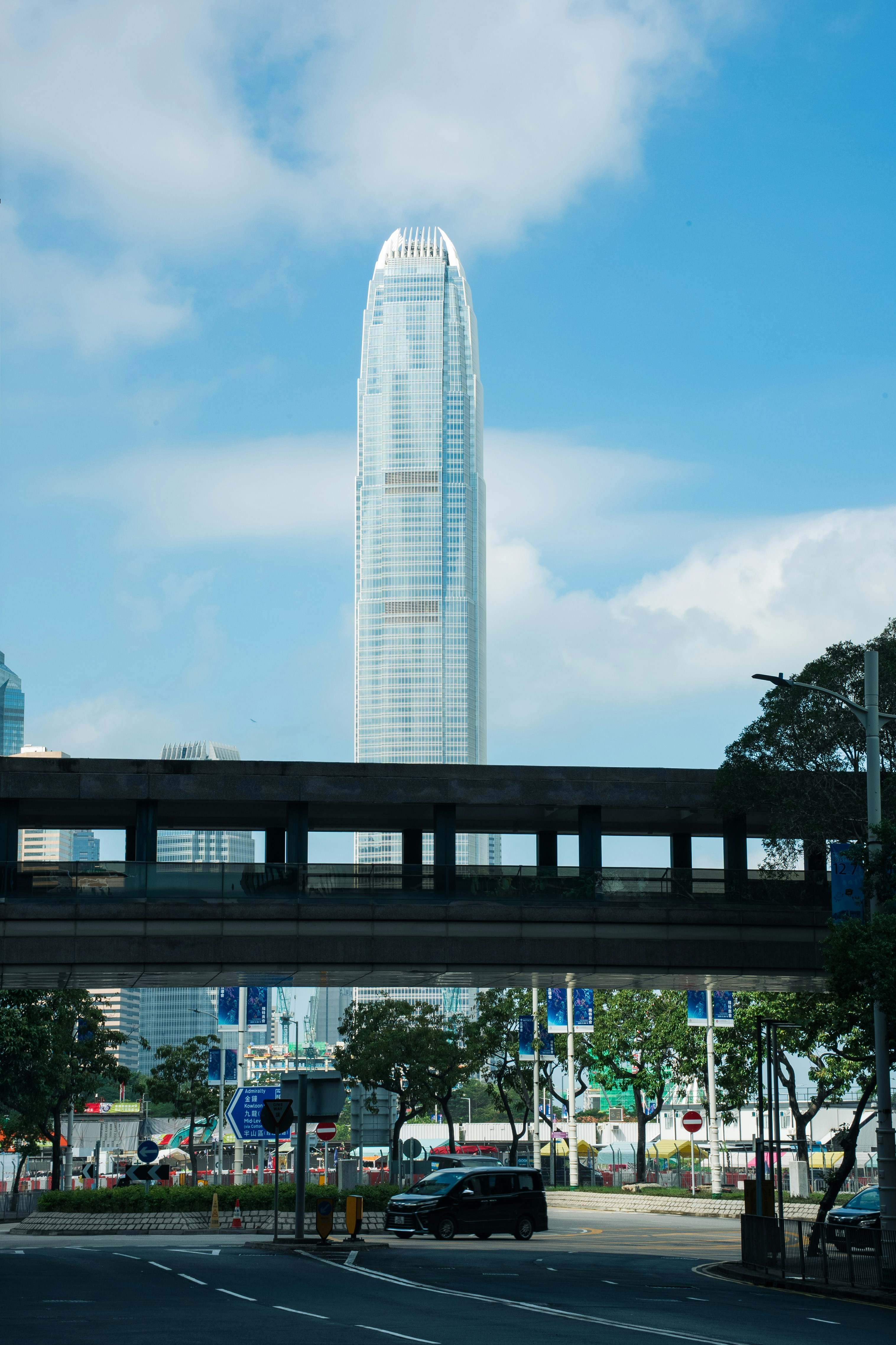 Vertical Tower Rising Above Streetlevel—Cityscape with Highway Overpass