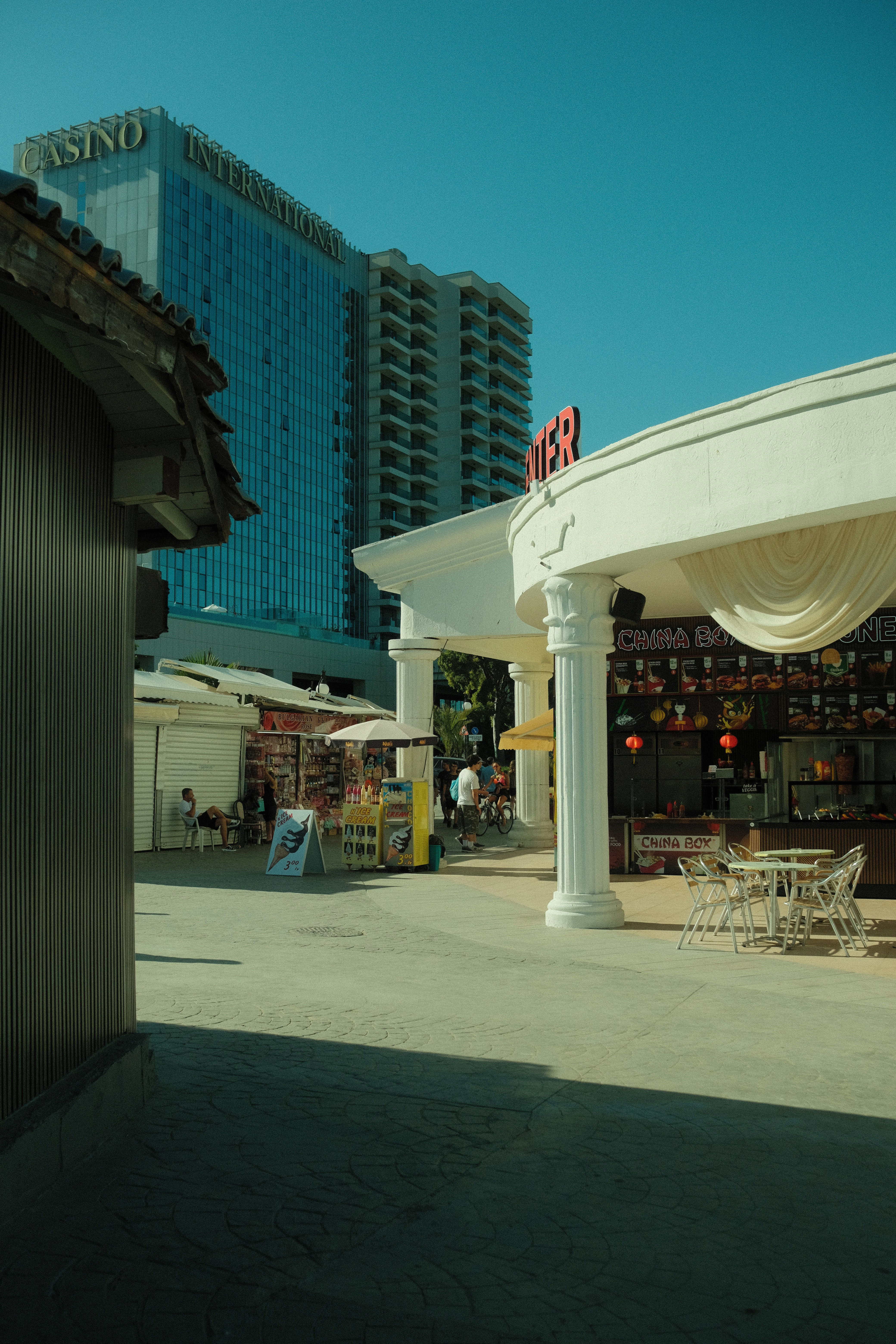 Courtyard Spotlight: Shadows, Shops, and a Stray Sunbeam