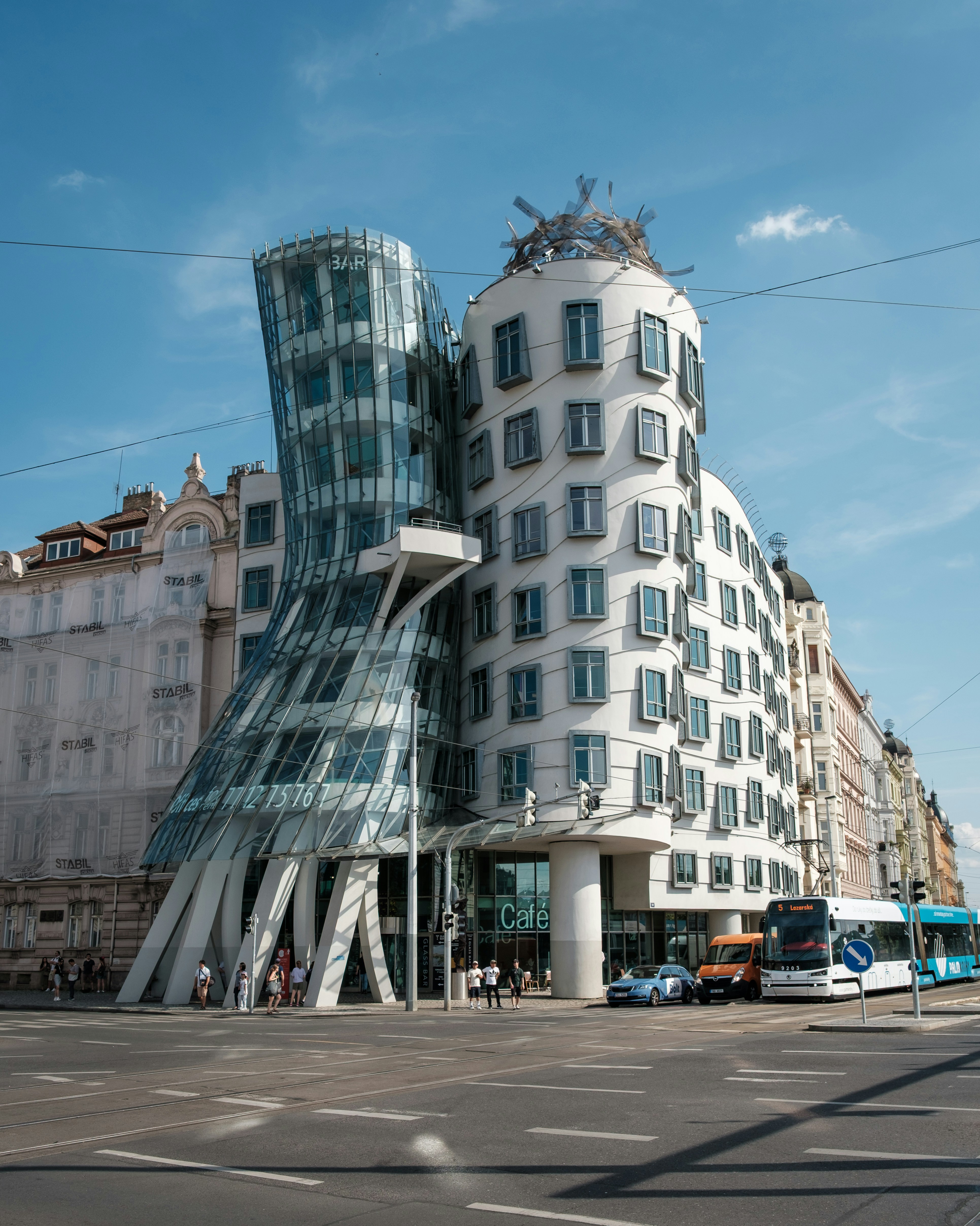 The Dancing Facades: A Curved Glass Tower Adjoins a Whimsical White Wave House