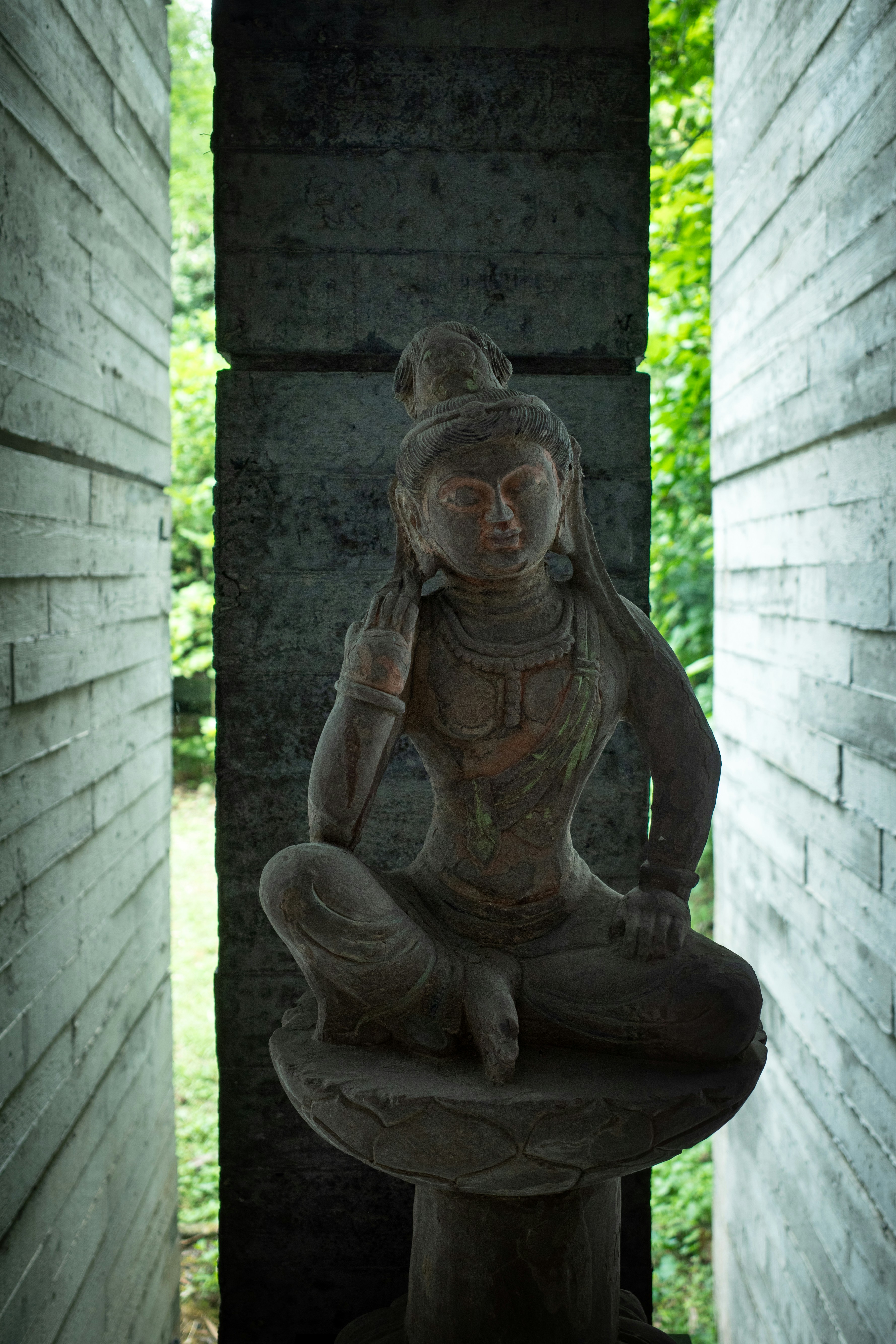 Serene Buddha Sentinel Between Slate Walls