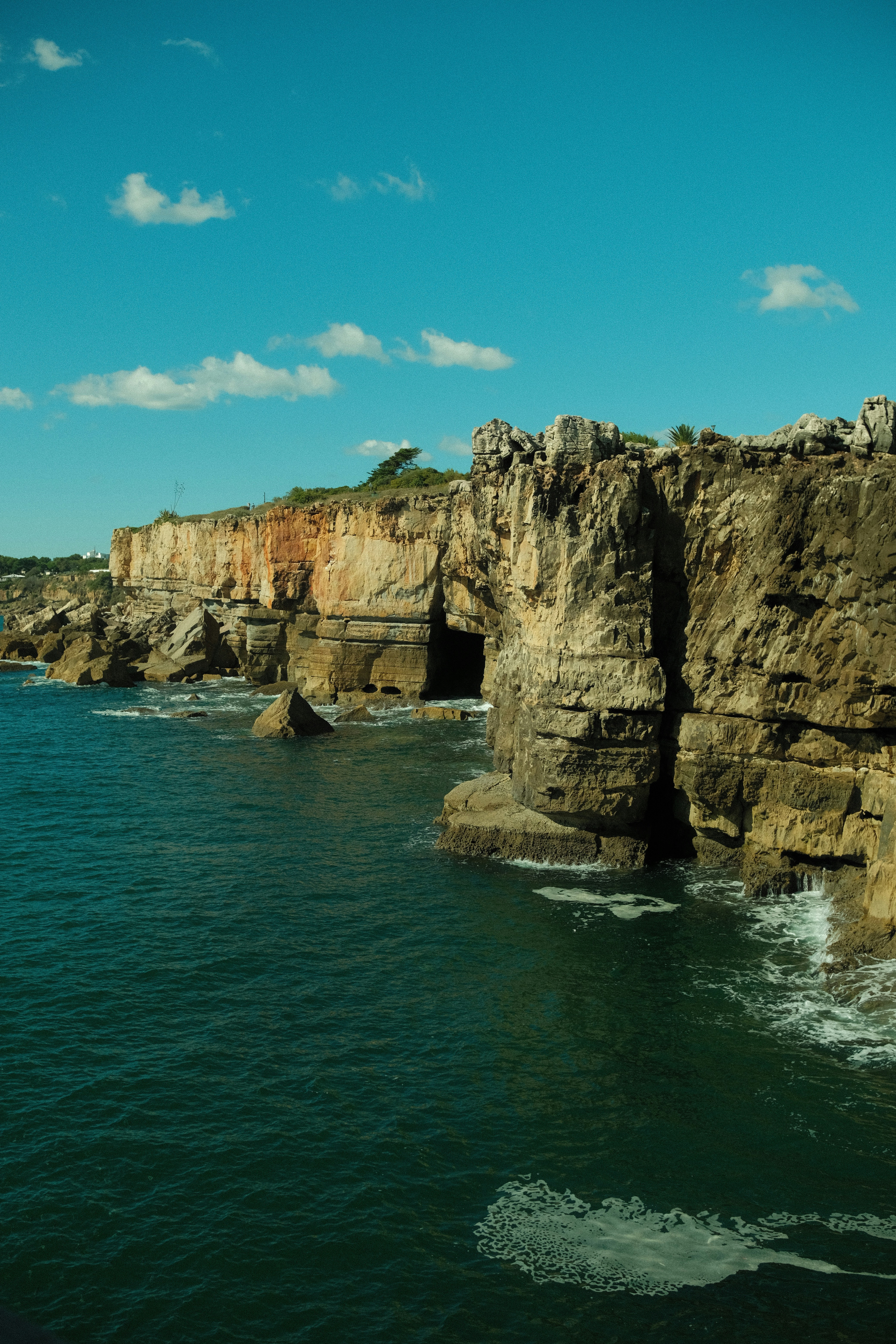 Cliffside Edge: Oceanic Blues Meet Weathered Face of the Coast