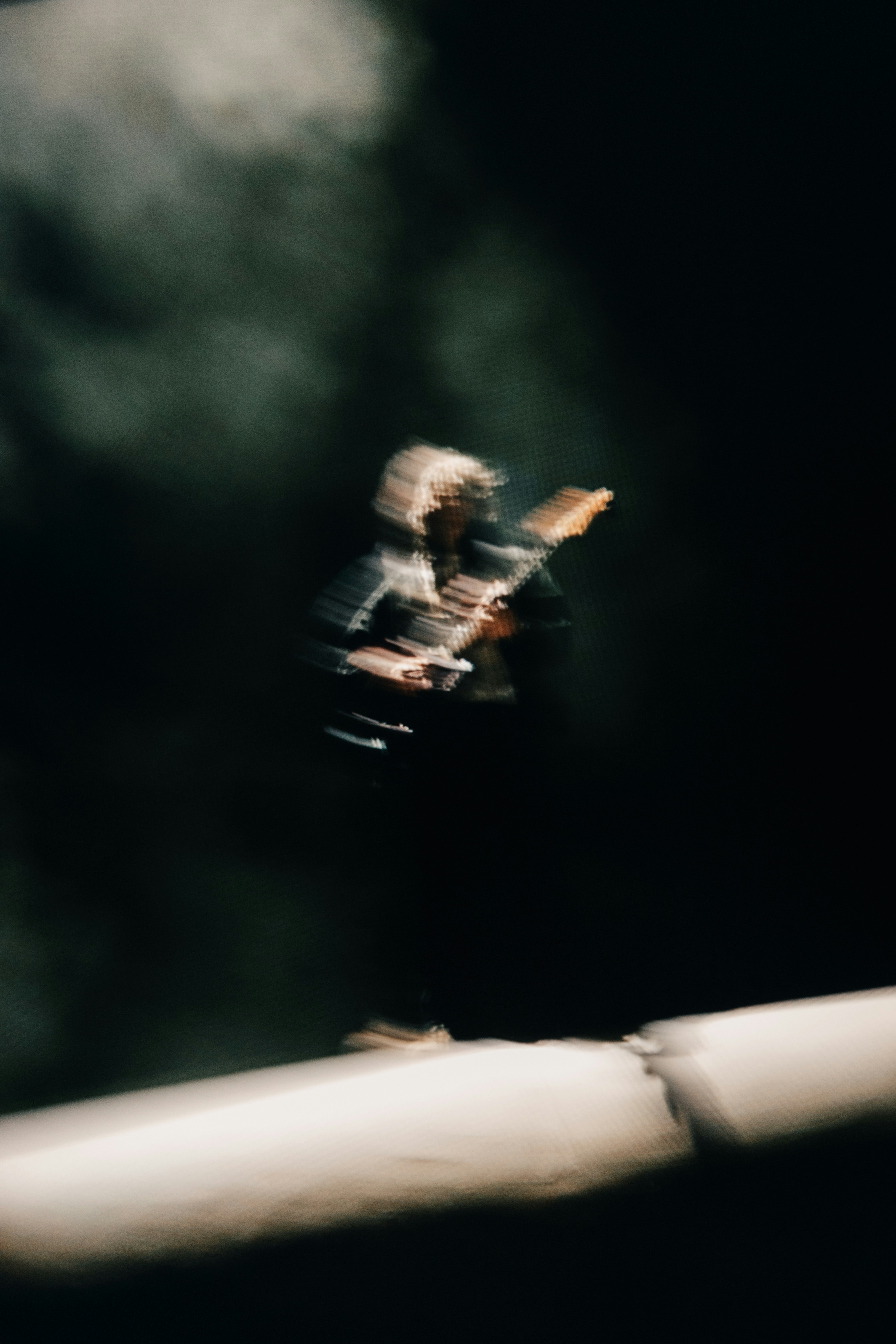 Blurry Night Session: A Guitarist in Soft Haloes