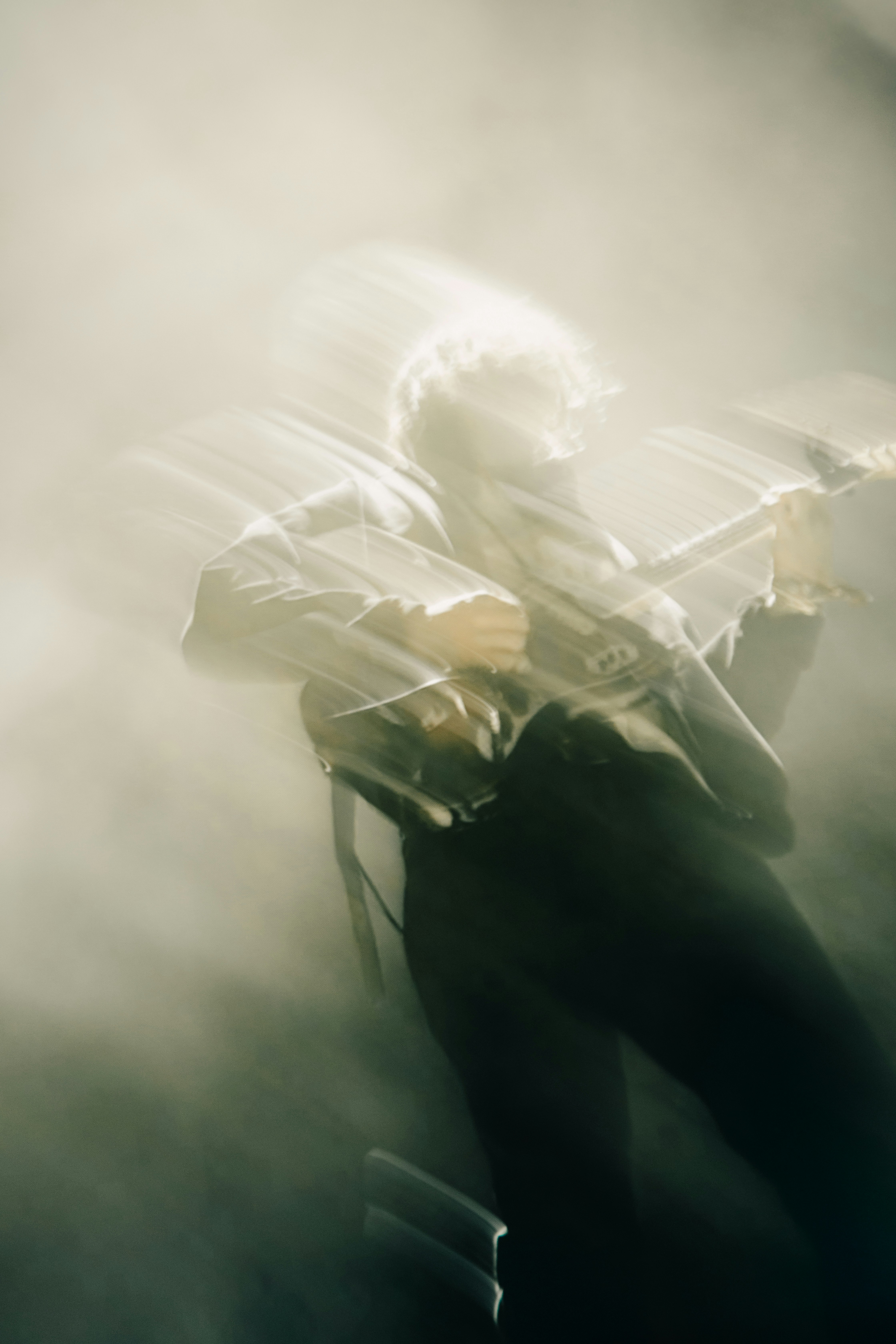 Whispering Strings: A Dreamy Double Exposure of a Guitarist