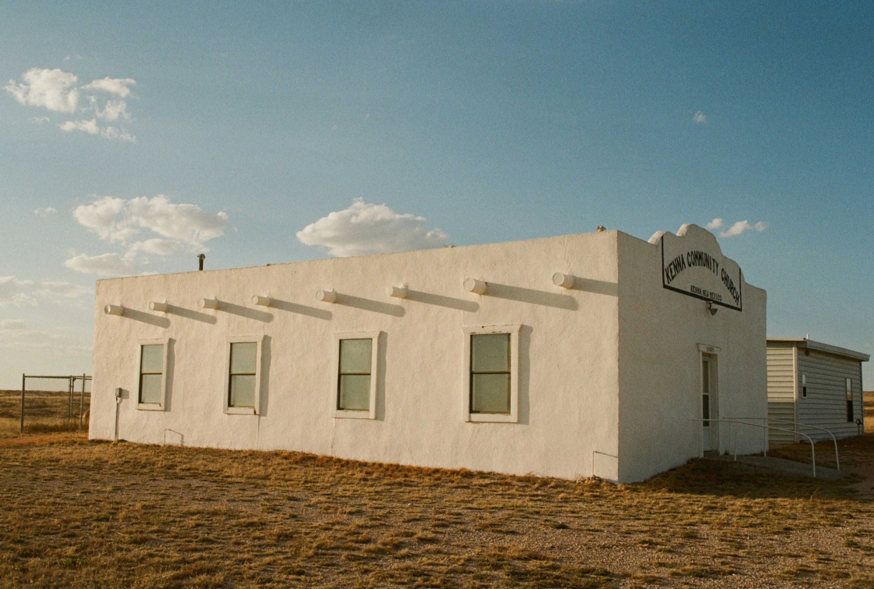 Deserted White Adobe Storefront under Open Sky