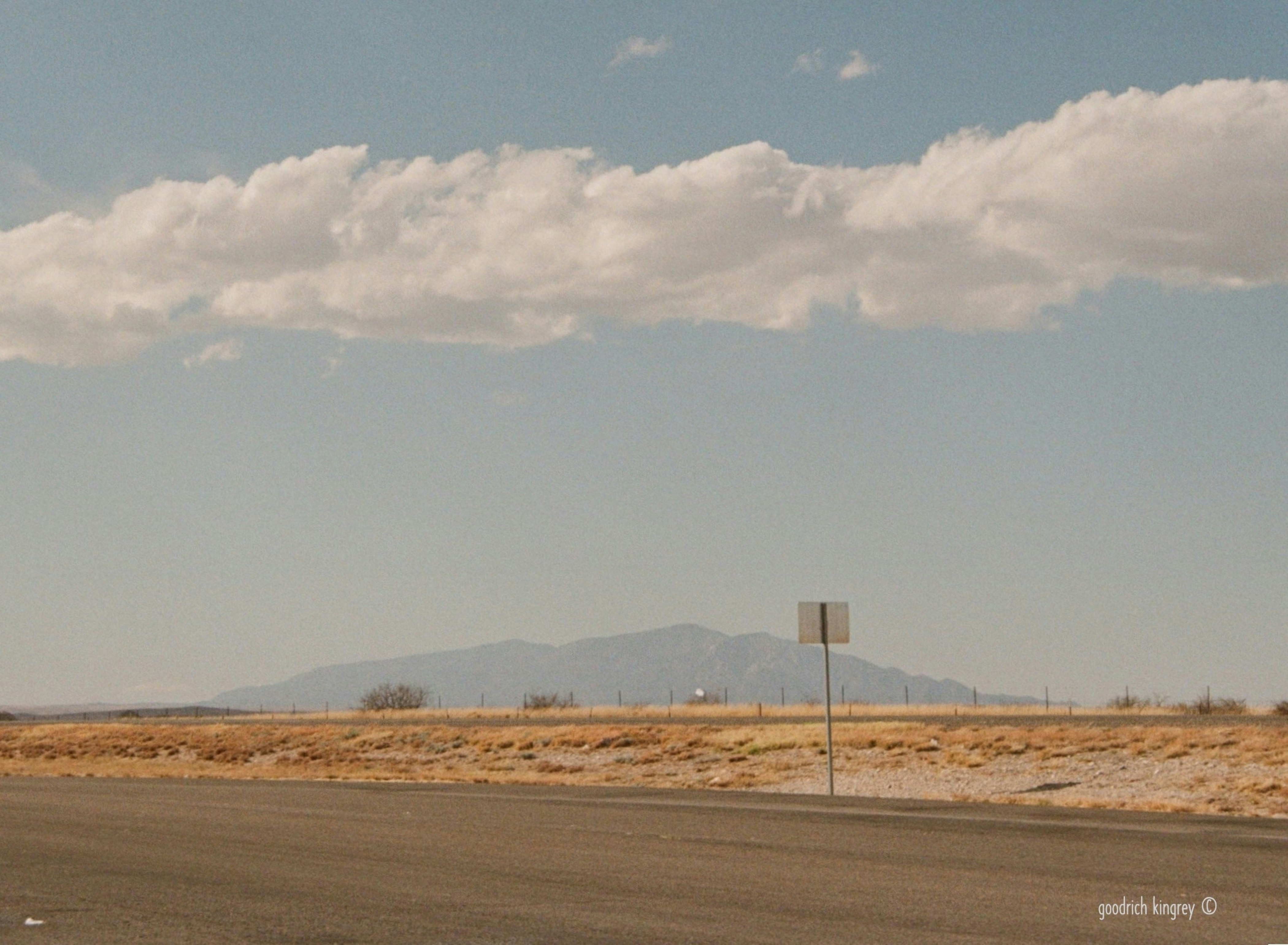 Desert Highway Horizon with a Lone Signpost