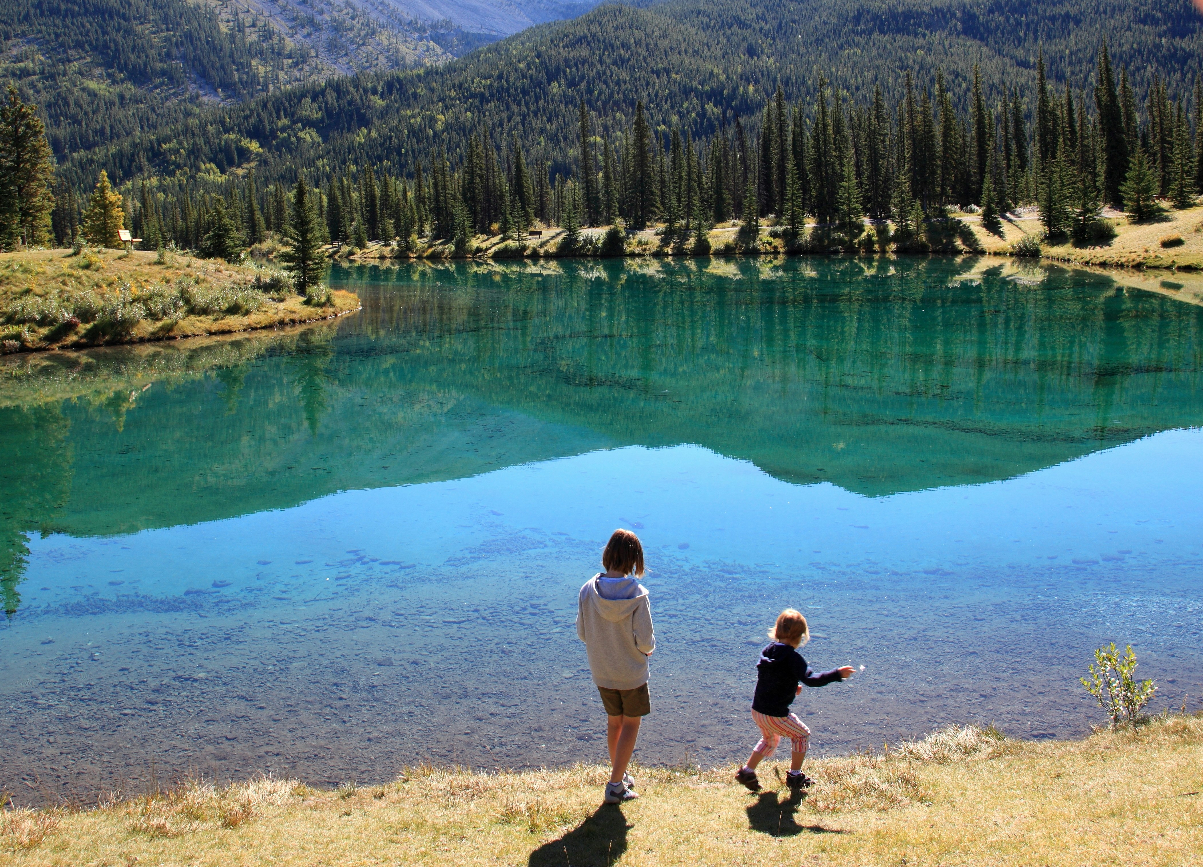 Two Figures by a Turquoise Alpine Lake