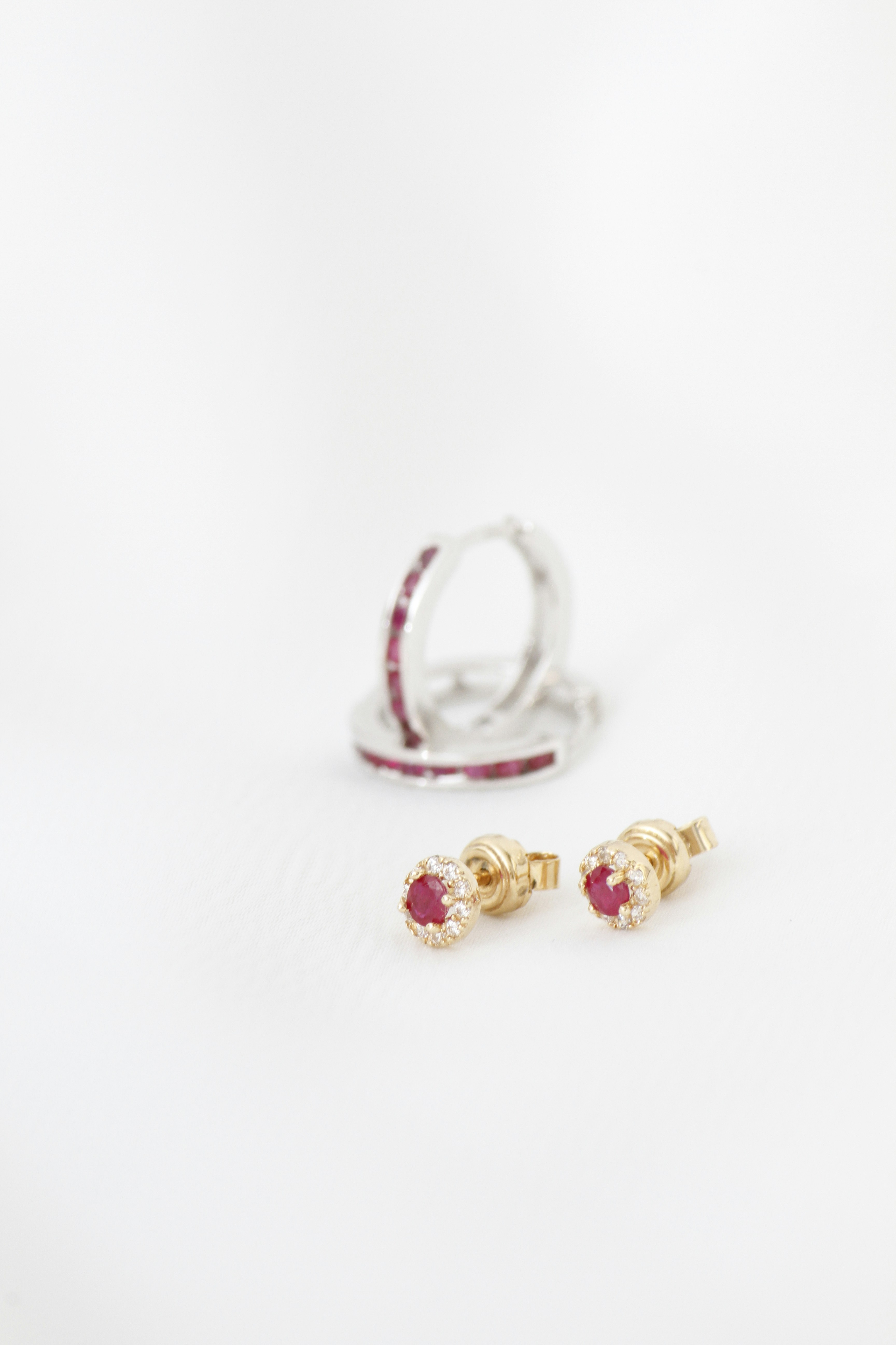Ruby Rings and Stud Earrings: Delicate Jewelry on White Silk
