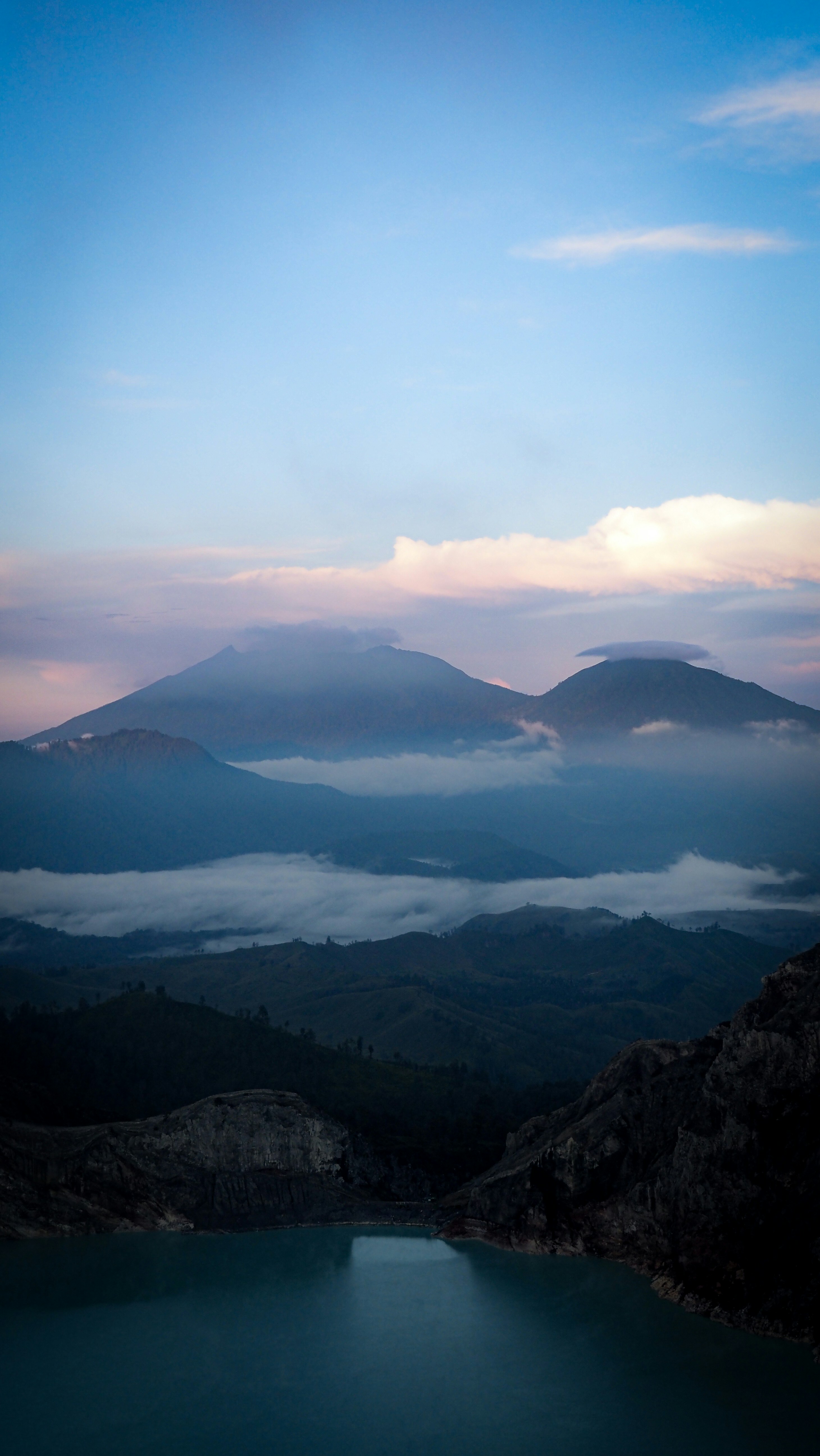 Mist-veiled Peaks Over a Serene Alpine Lake