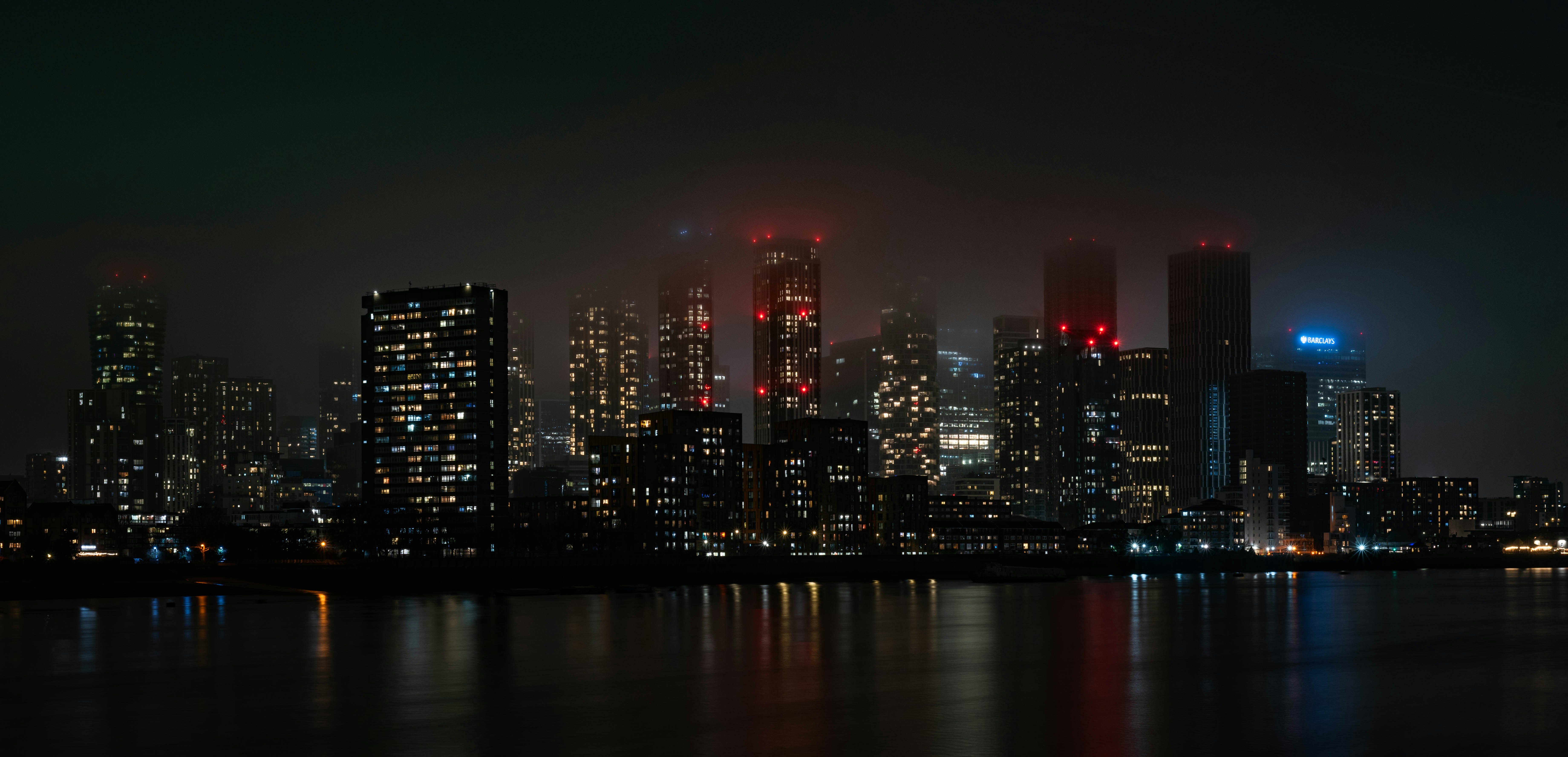 Neon Skyline at Dusk: Reflections over a Quiet River