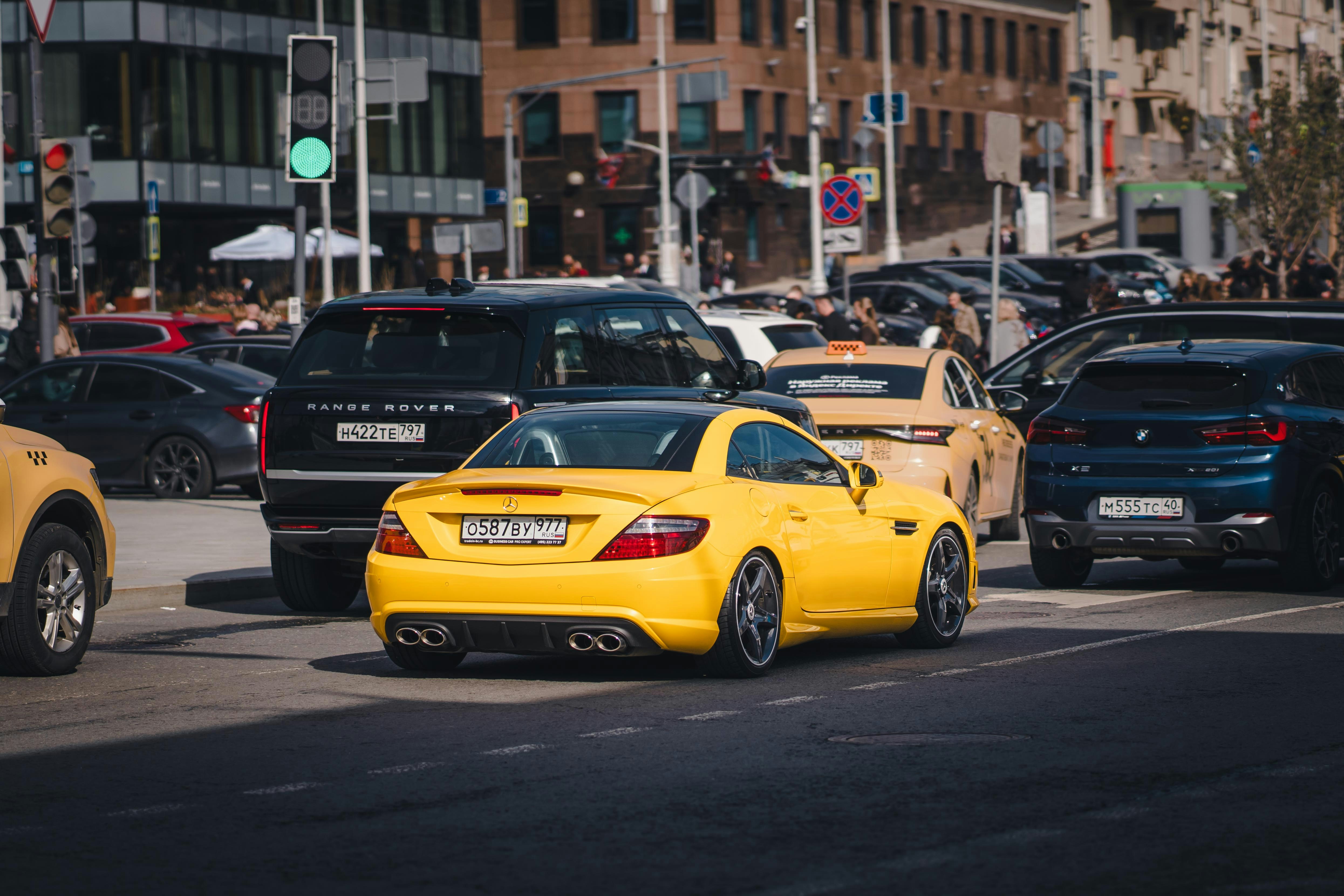 Yellow Convertible Amid City Traffic Jam