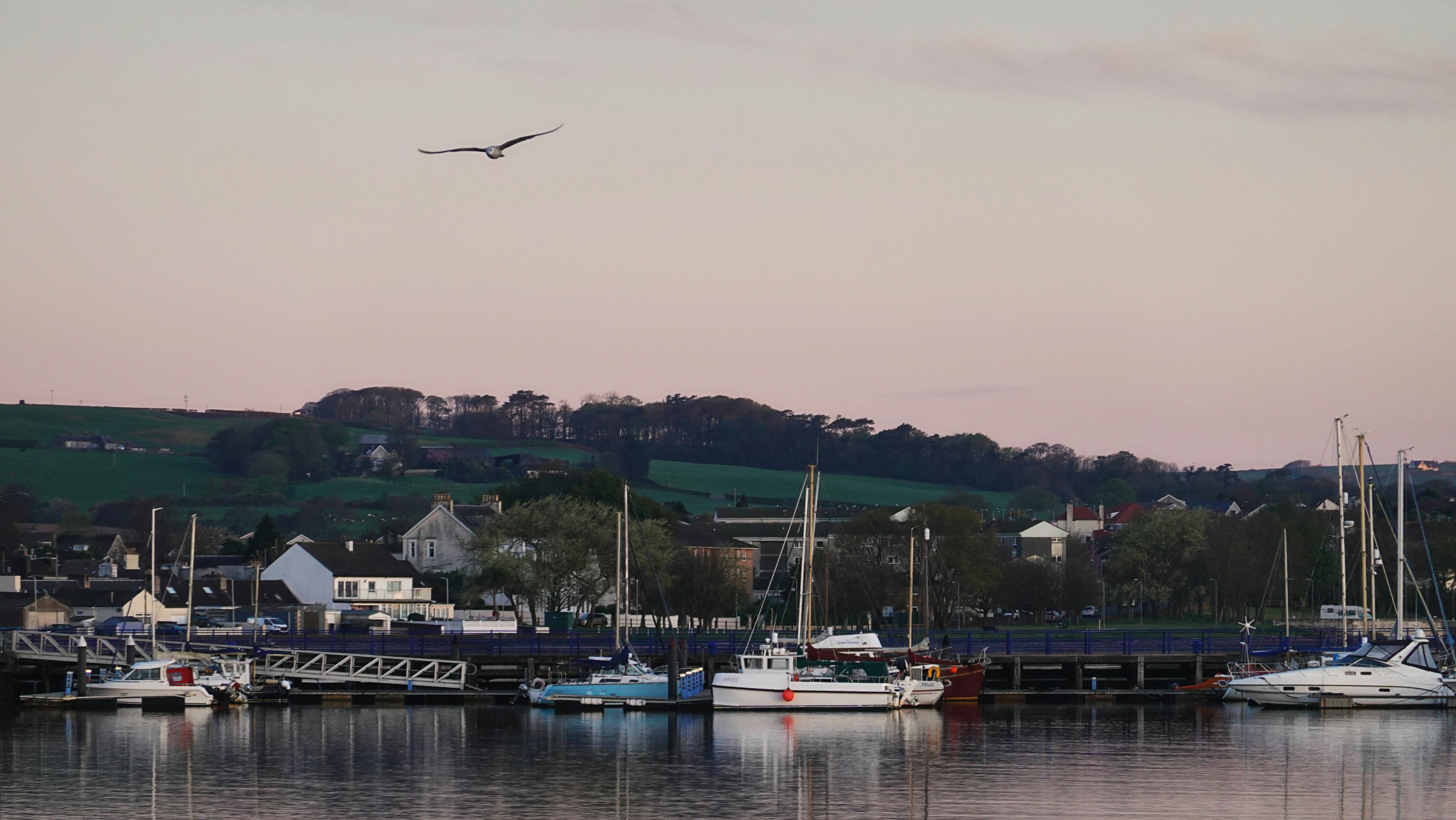 Moorings at Dusk: Boats Quietly Rest Along a Seaside Village