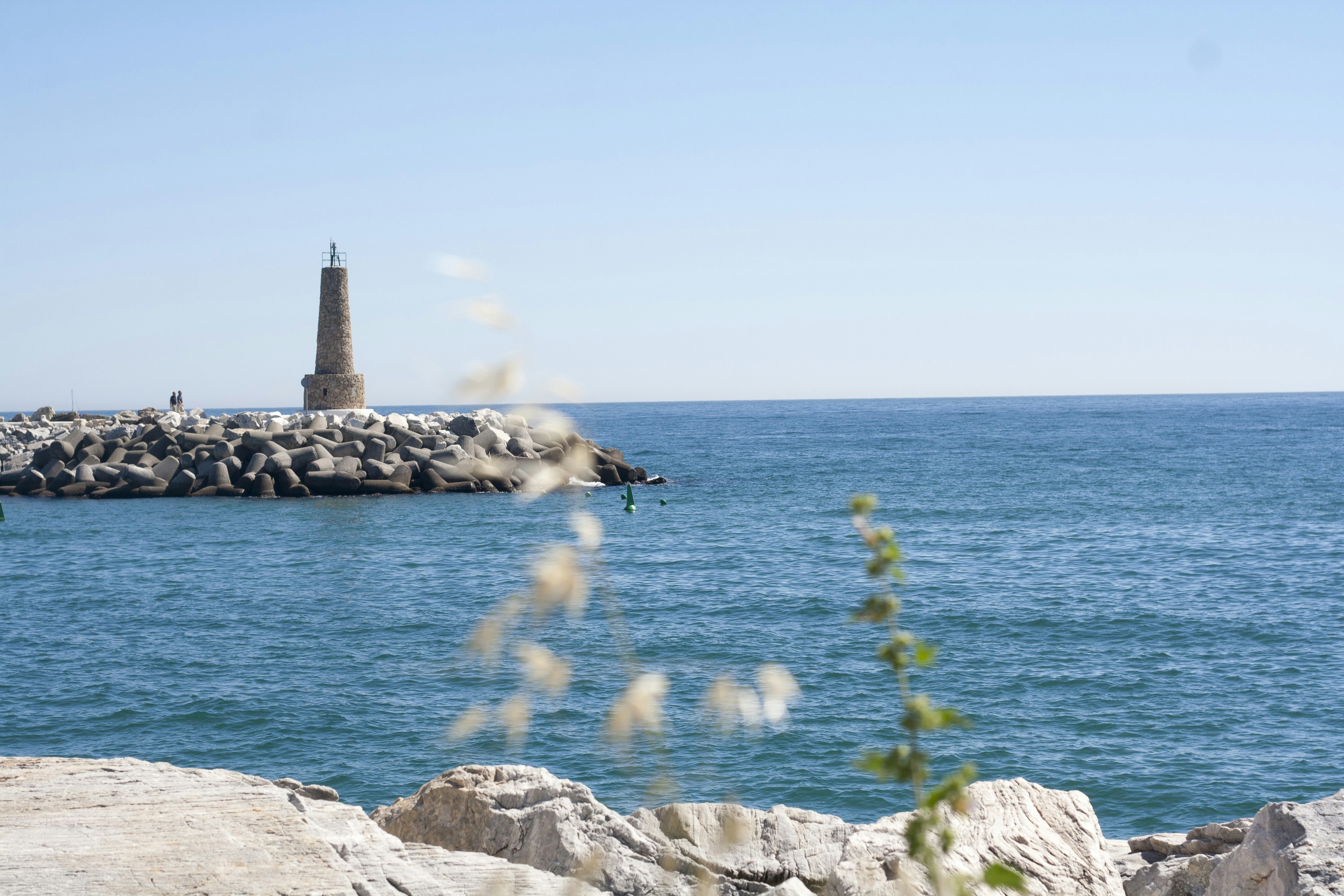 Lighthouse Watch from a Wind-Swept Promenade
